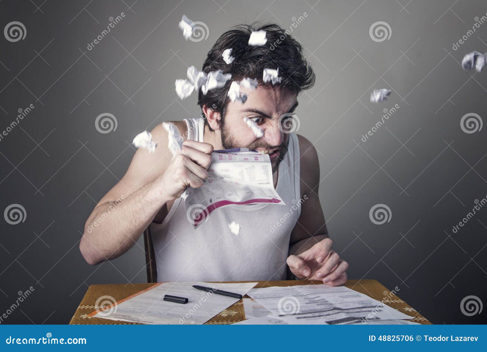 Man tearing apart bills stock photo. Image of problems - 48825706
