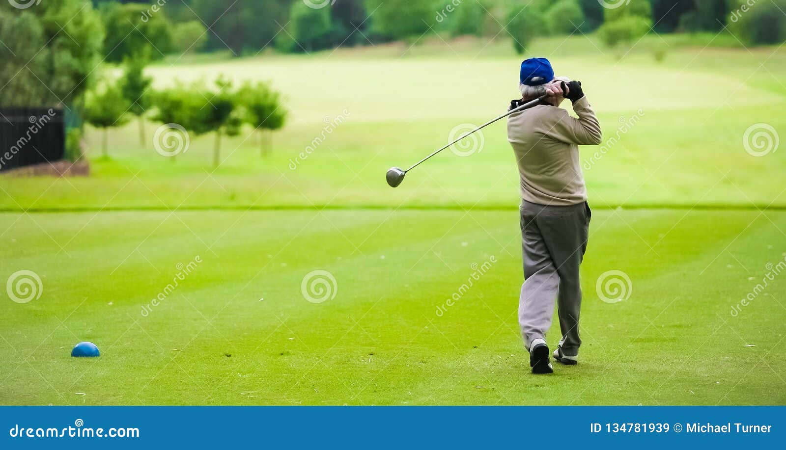 Man Teeing Off on a Golf Course with a Driver Editorial Stock Image ...
