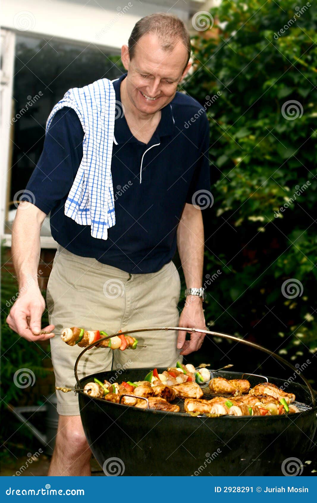Man tending barbecue stock image. Image of appetizing - 2928291