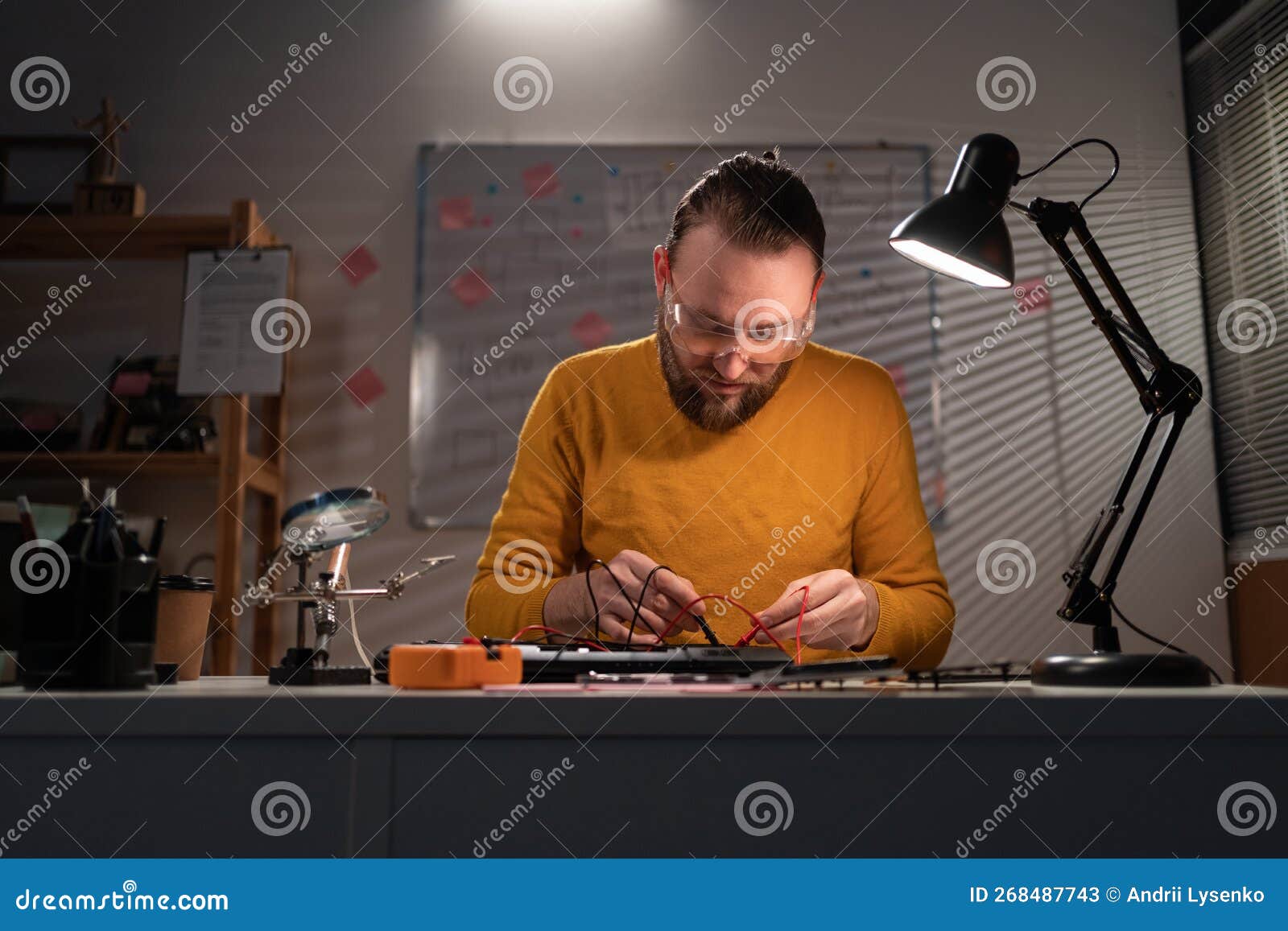 Man Testing Laptop Motherboard Using Multimeter Working in His Workshop ...