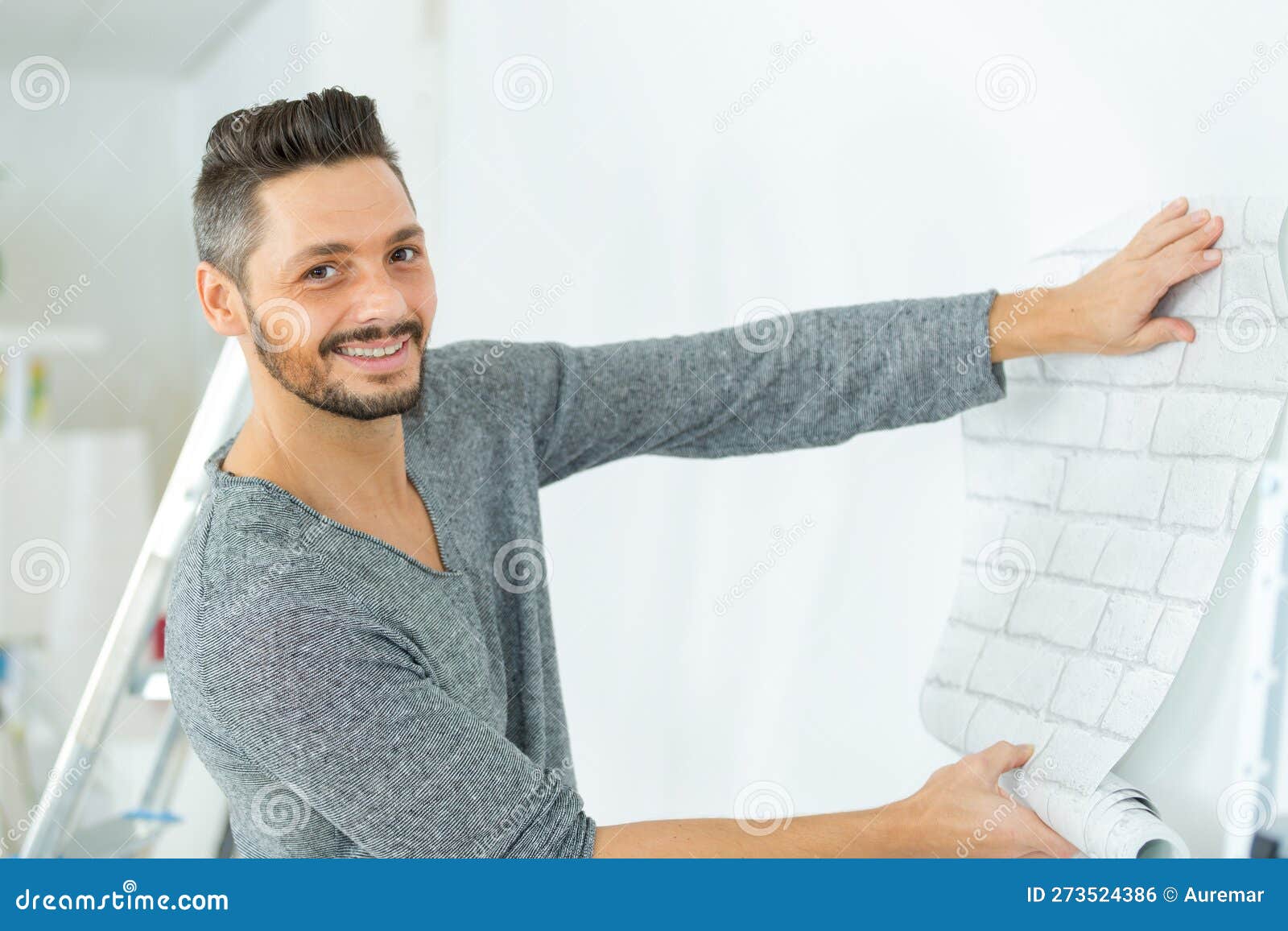 Man Testing Wall Paper on Wall Stock Photo - Image of working, sheet ...