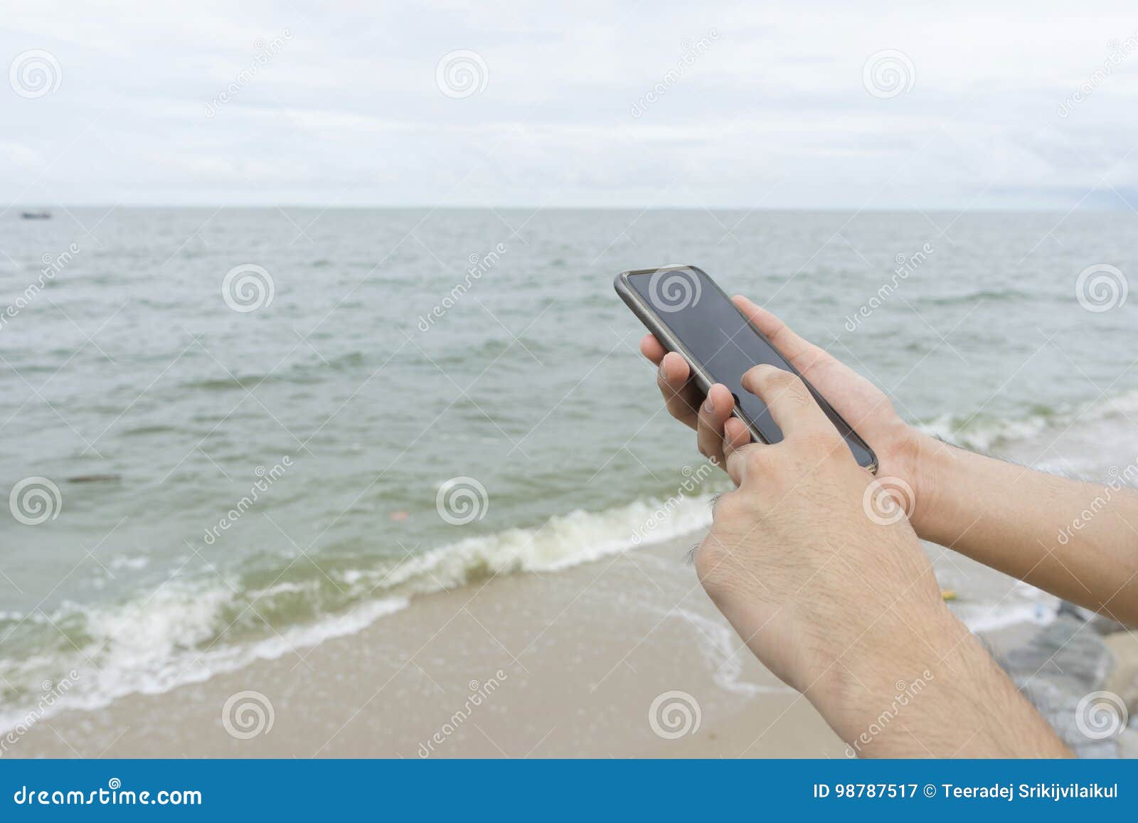 A Man Texting Cellphone on the Beach Stock Image - Image of phone, left ...