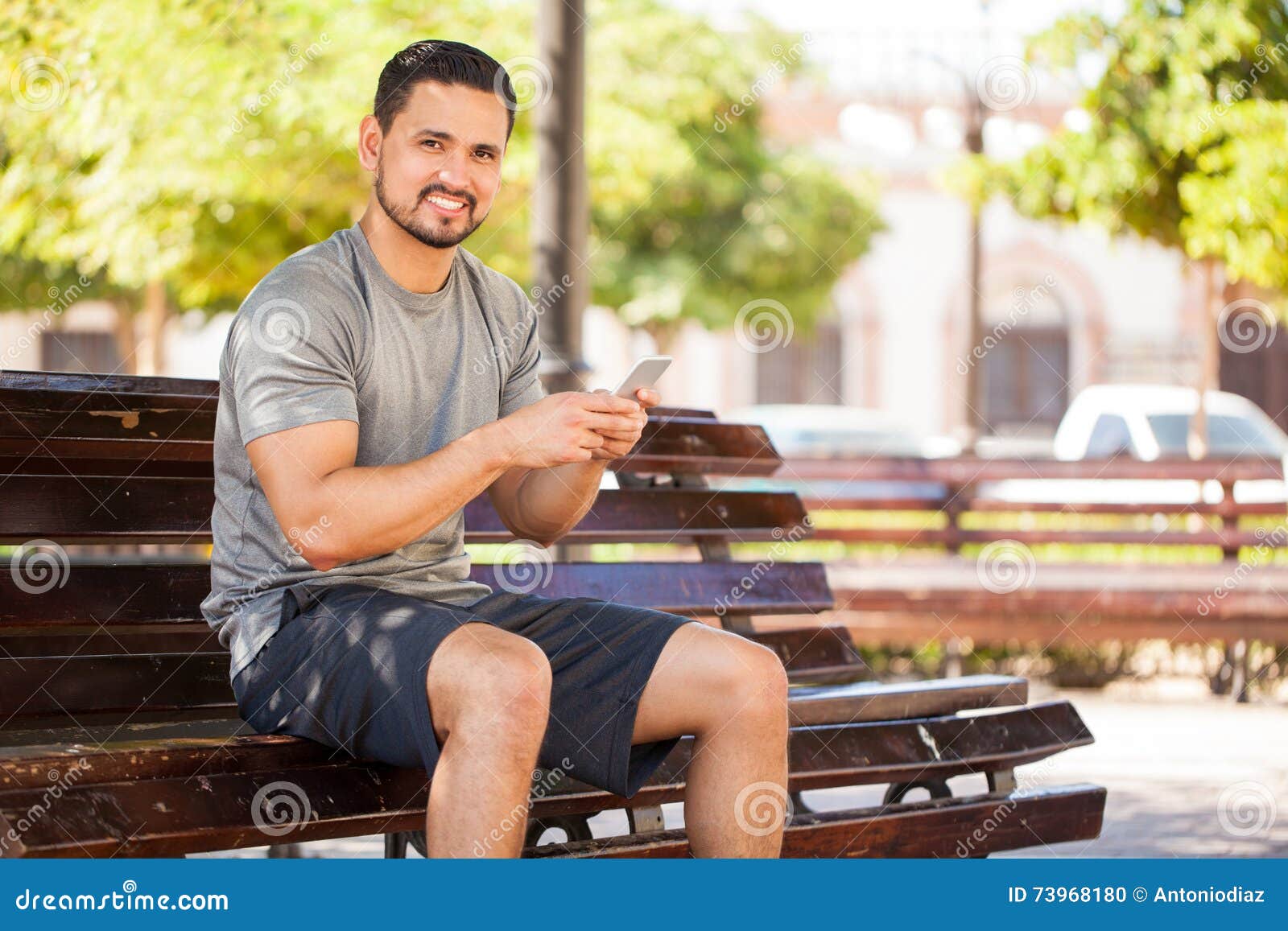Man Texting on His Smartphone at a Park Stock Photo - Image of break ...