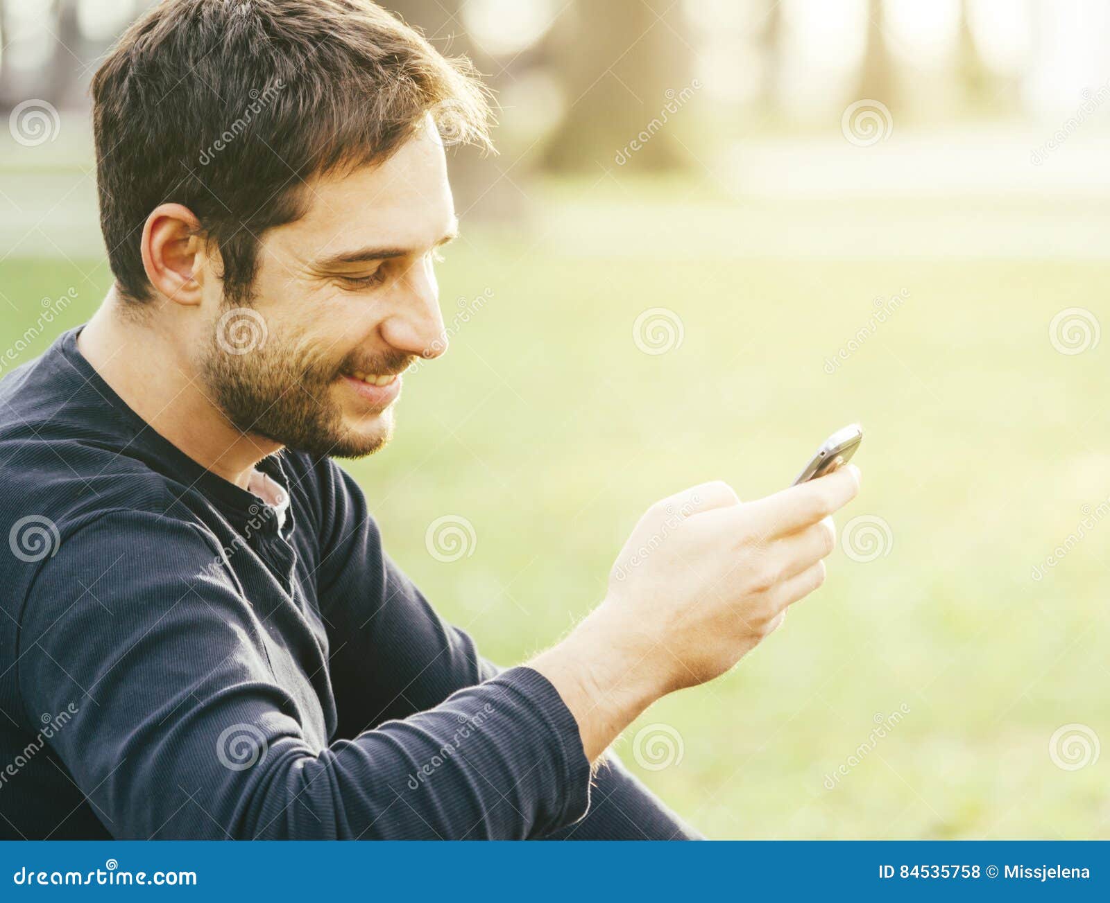 Man texting massage stock photo. Image of bokeh, outside - 84535758