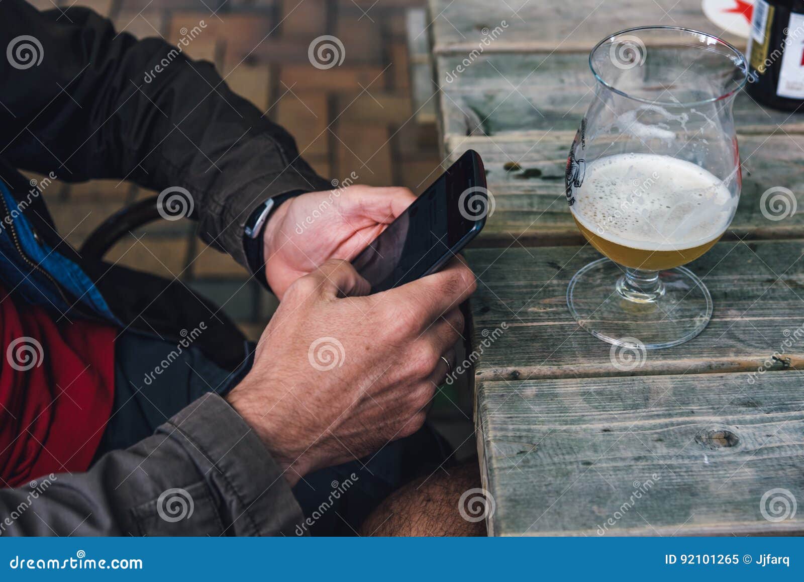 Man Texting on Phone while Drinking Beer Sitting on a Bar Stock Image ...