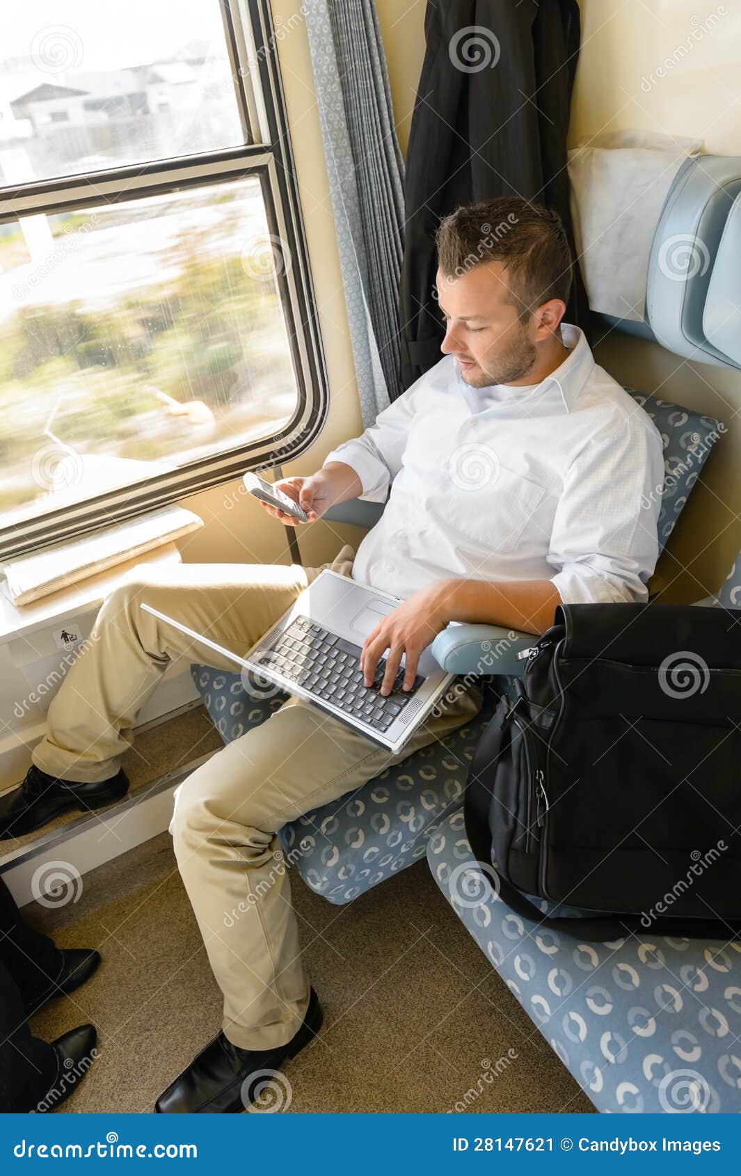 Man Texting on Phone Holding Laptop Train Stock Image - Image of ...