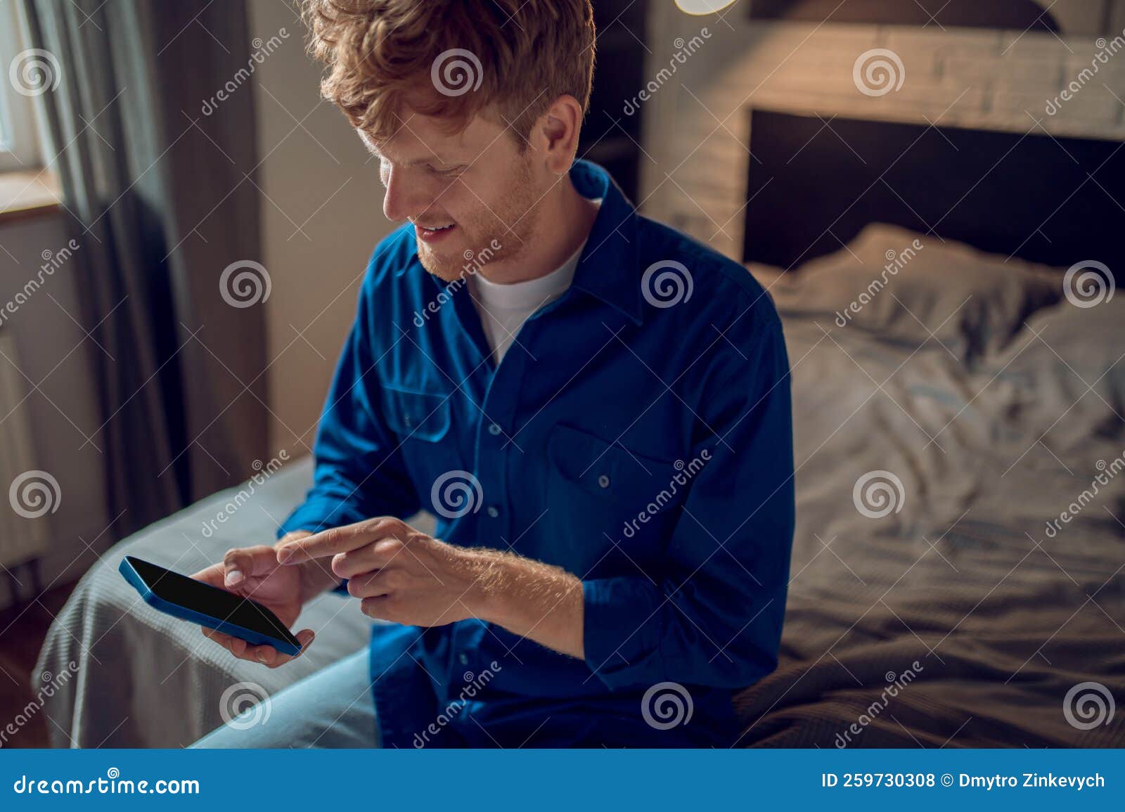 A Man Texting on a Phone and Looking Involved Stock Photo - Image of ...