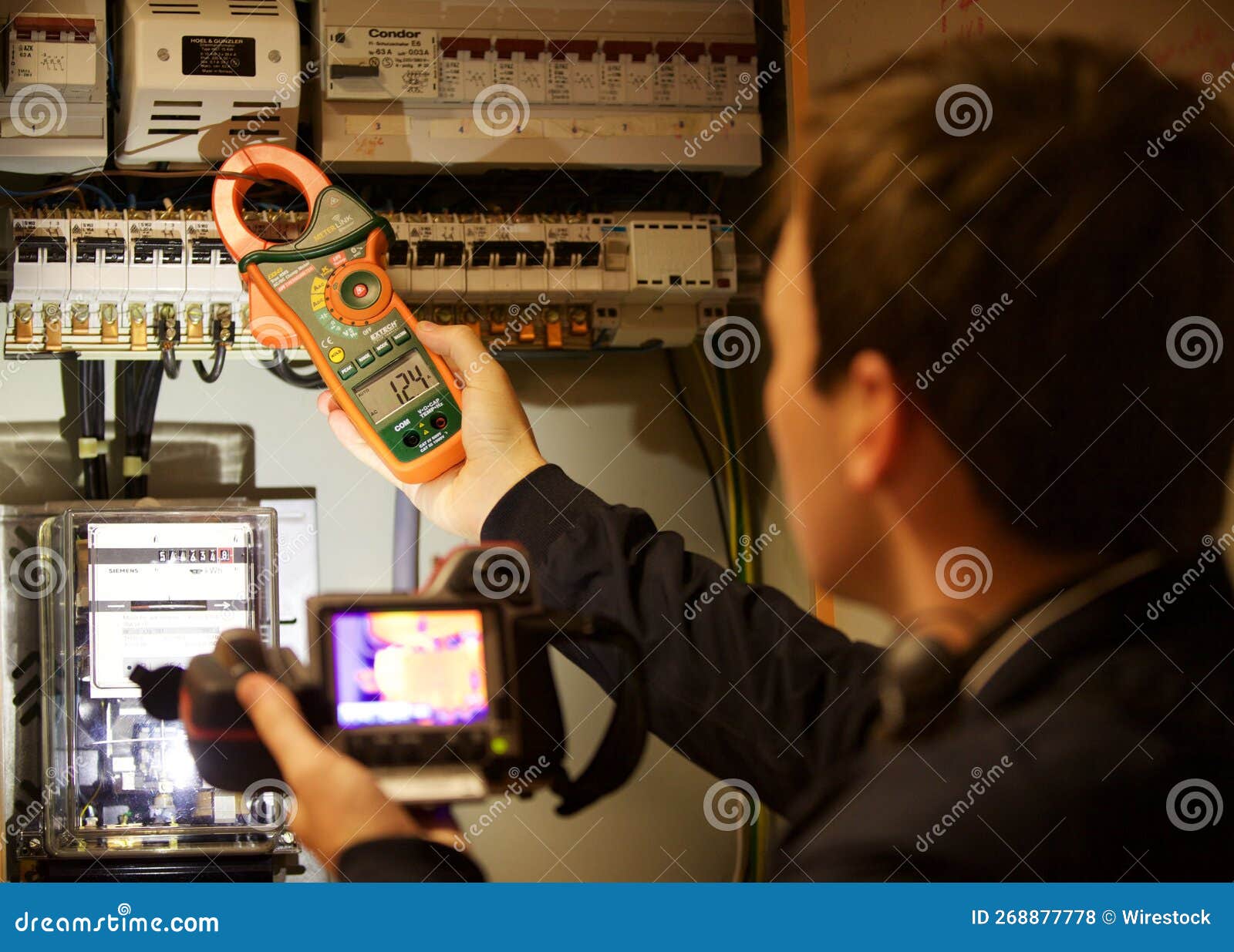 Man with Thermal Imaging Camera Checking Electric Installation with an ...