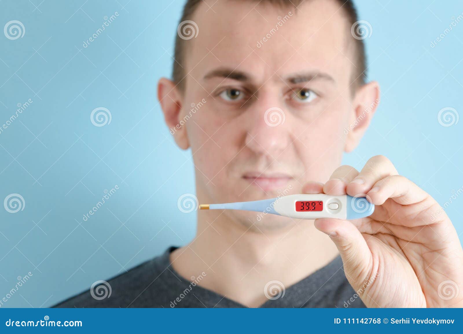 Man with a Thermometer in His Hand. High Body Temperature Stock Photo ...