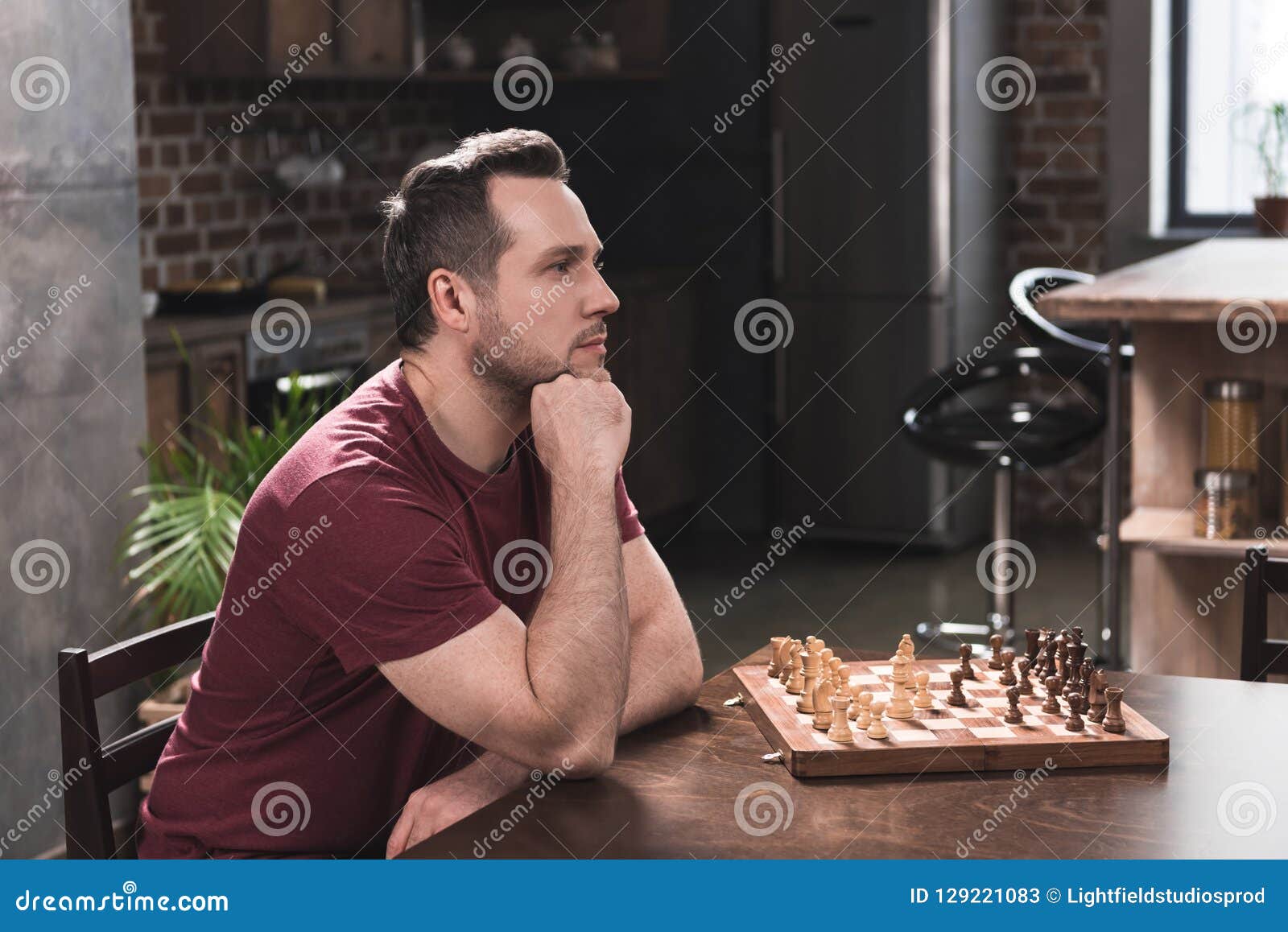 Handsome Man Sitting at Table and Thinking about Making a Move Stock ...