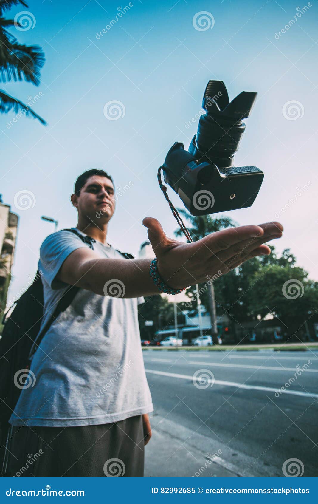 Man Throwing Black Camera In Air Picture. Image: 82992685