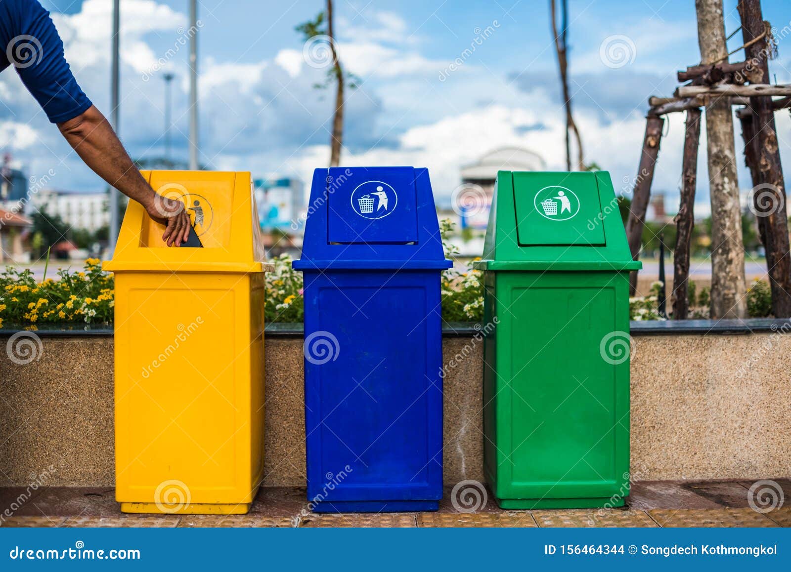 Man Throwing His Cell Phone in Trash Bin in a Park Stock Photo - Image ...