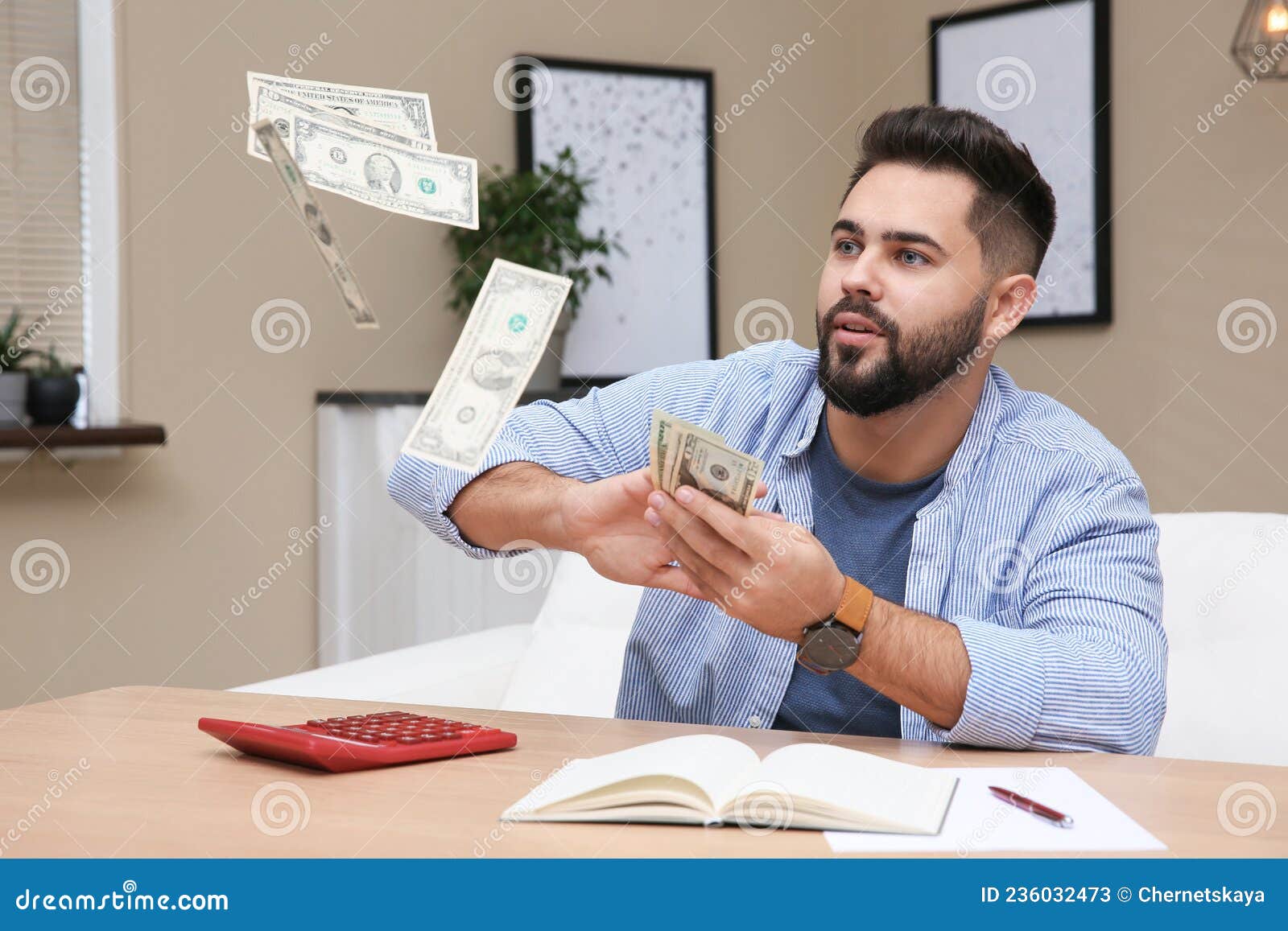 Young Man Throwing Money at Table Indoors Stock Image - Image of ...