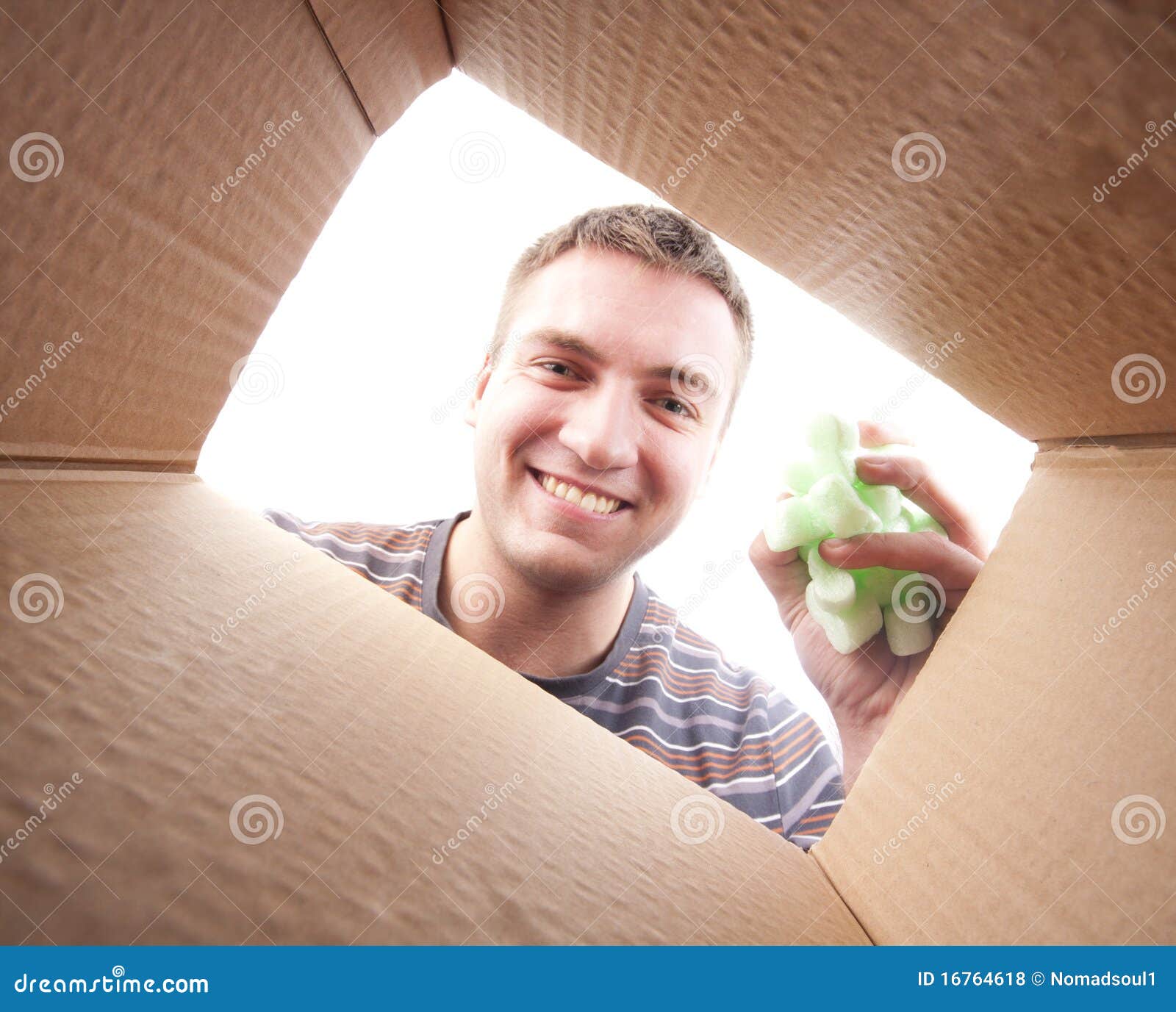 Man Throwing Packing Polyfoam into Cardboard Box Stock Photo - Image of ...