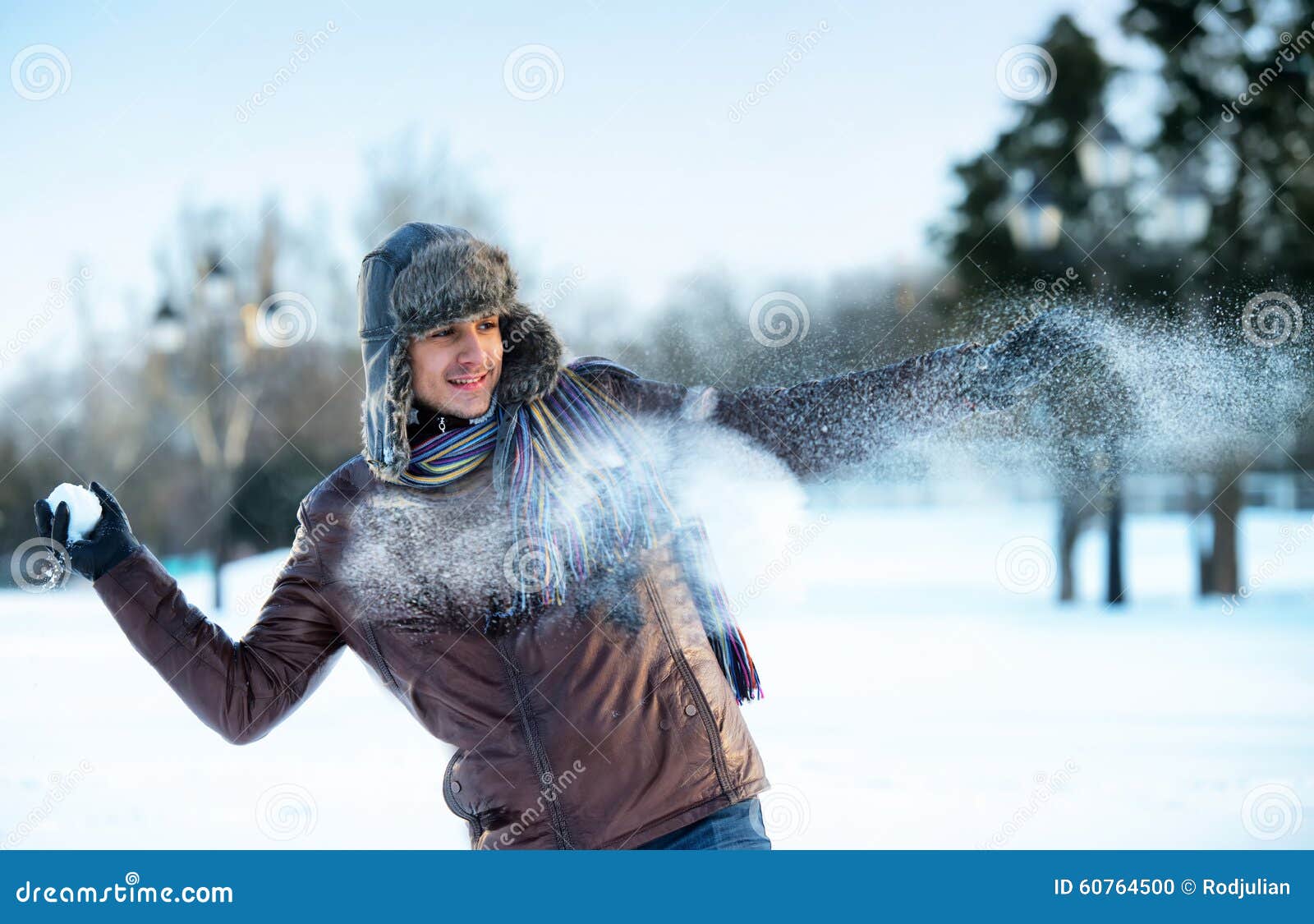 Man throwing a snowball stock photo. Image of cheerful - 60764500