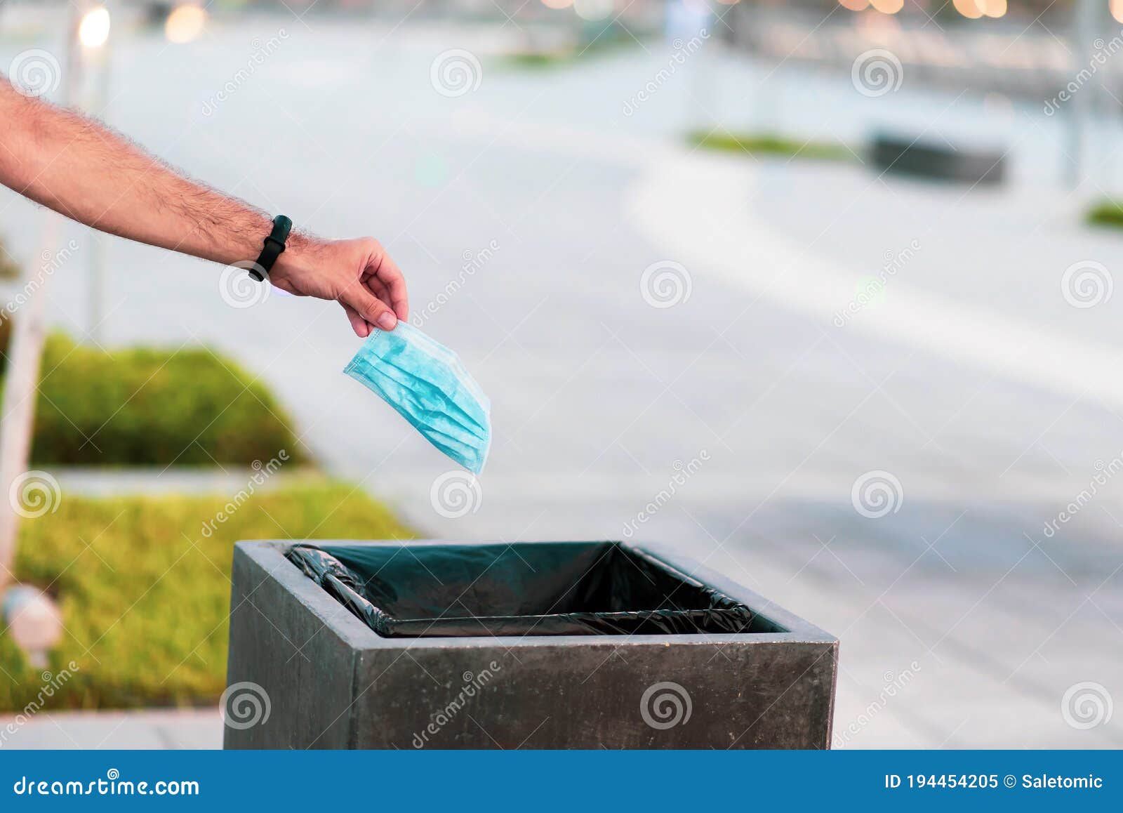 Man Throwing Used Disposable Protective Surgical Mask into the Garbage ...