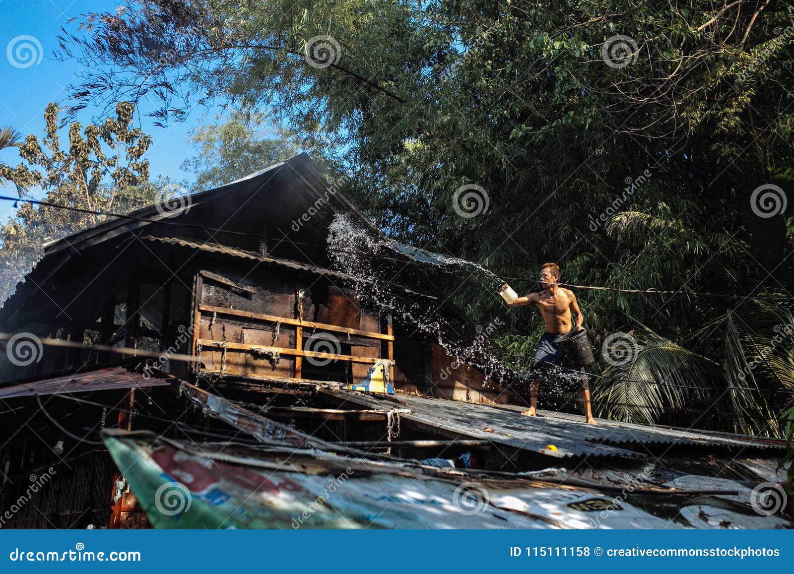 Man Throwing Water On Roof Picture. Image: 115111158