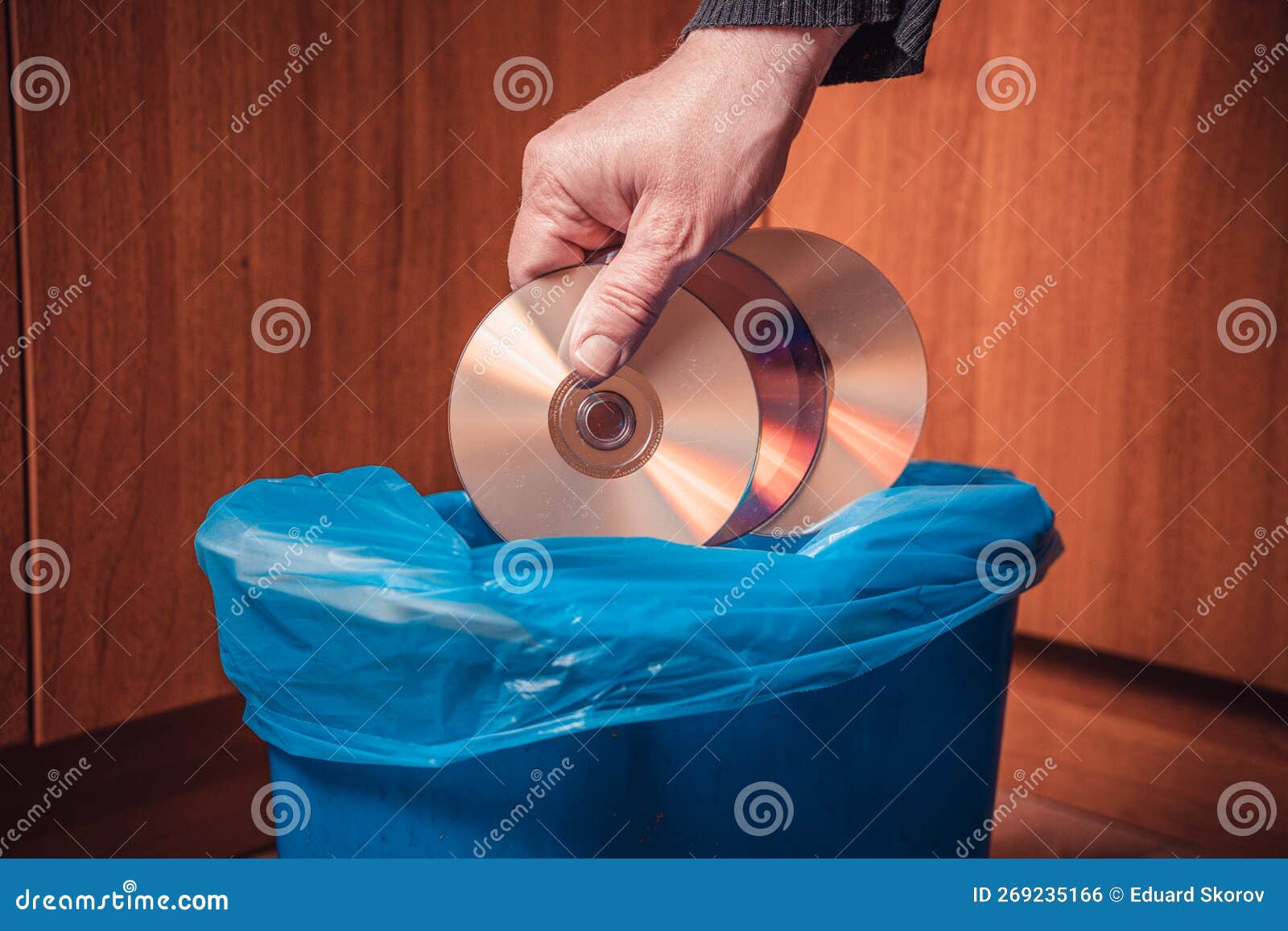 A Man Throws CDs into the Trash Can. Man S Hand with CDs and Trash Can ...