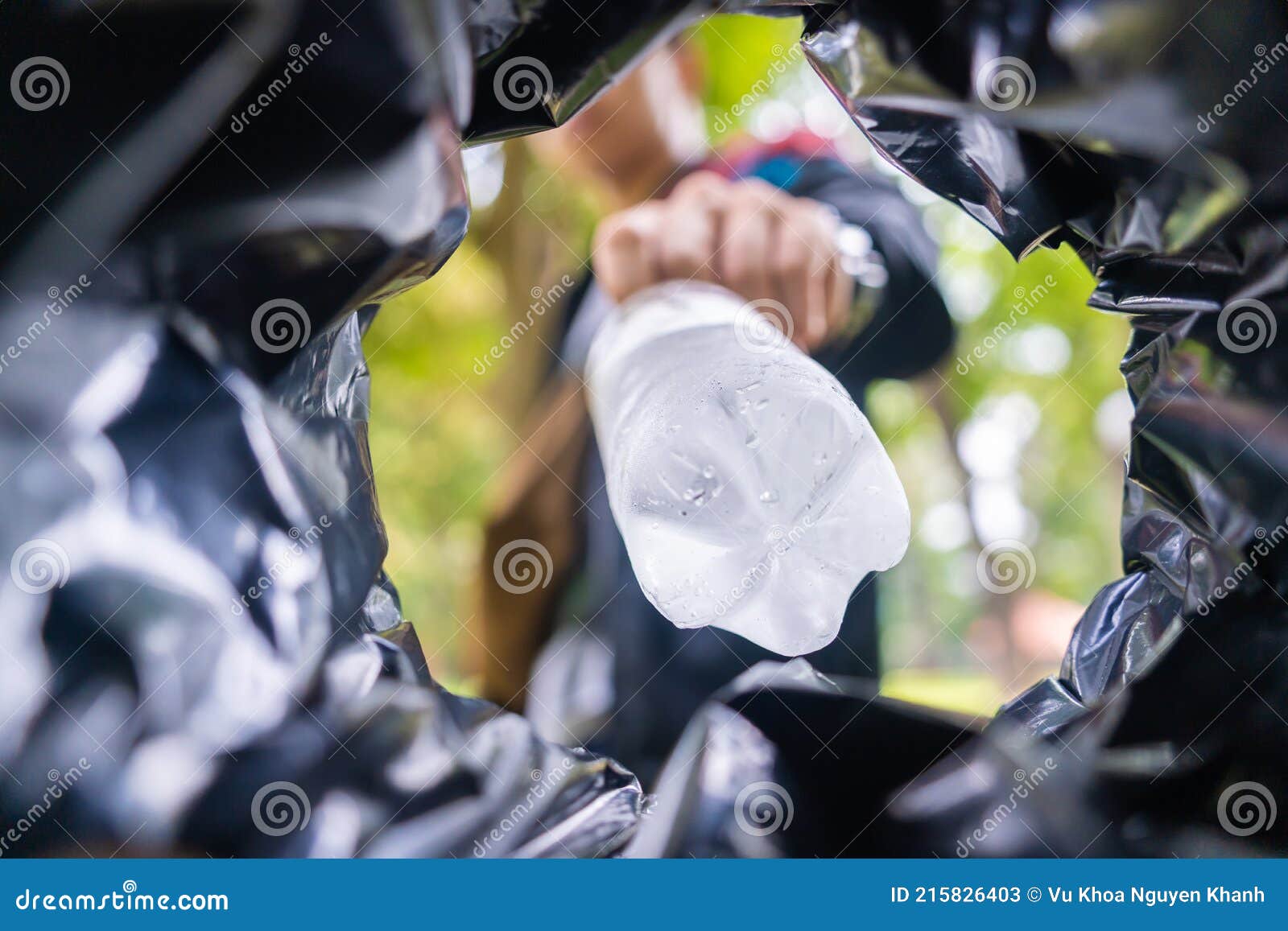 Man Throws Garbage into a Garbage Can on the Street. with a Worm View ...