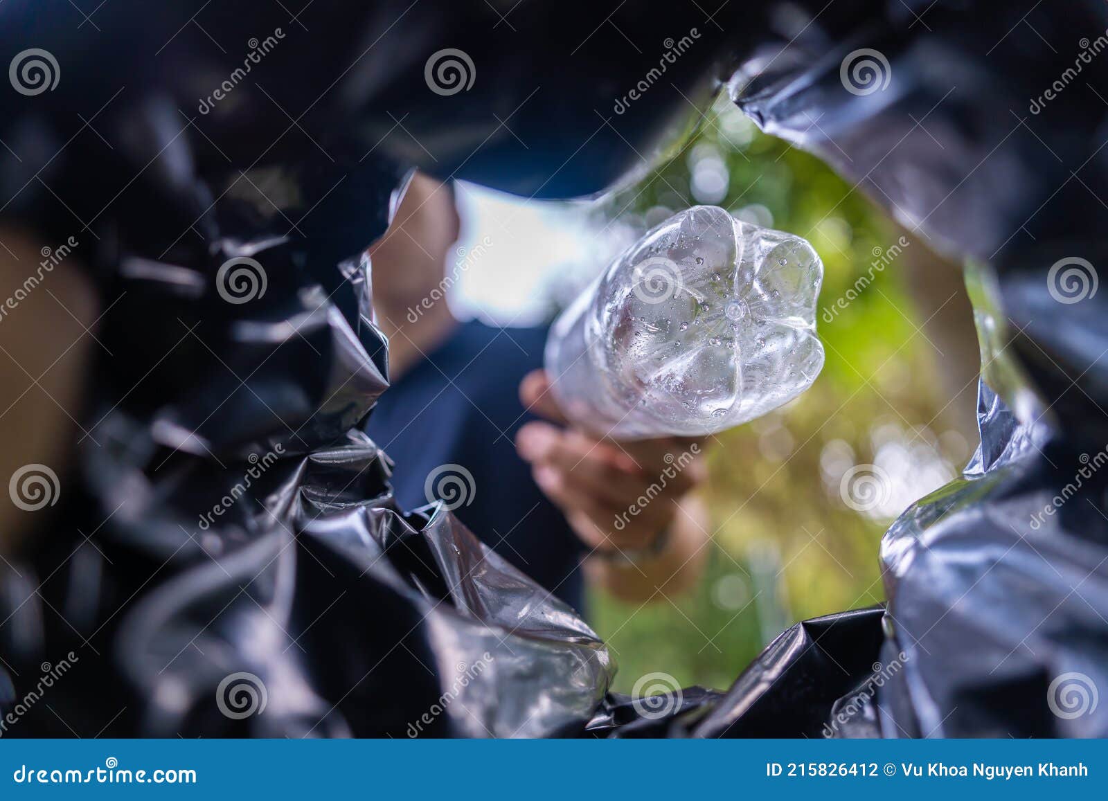 Man Throws Garbage into a Garbage Can on the Street. with a Worm View ...