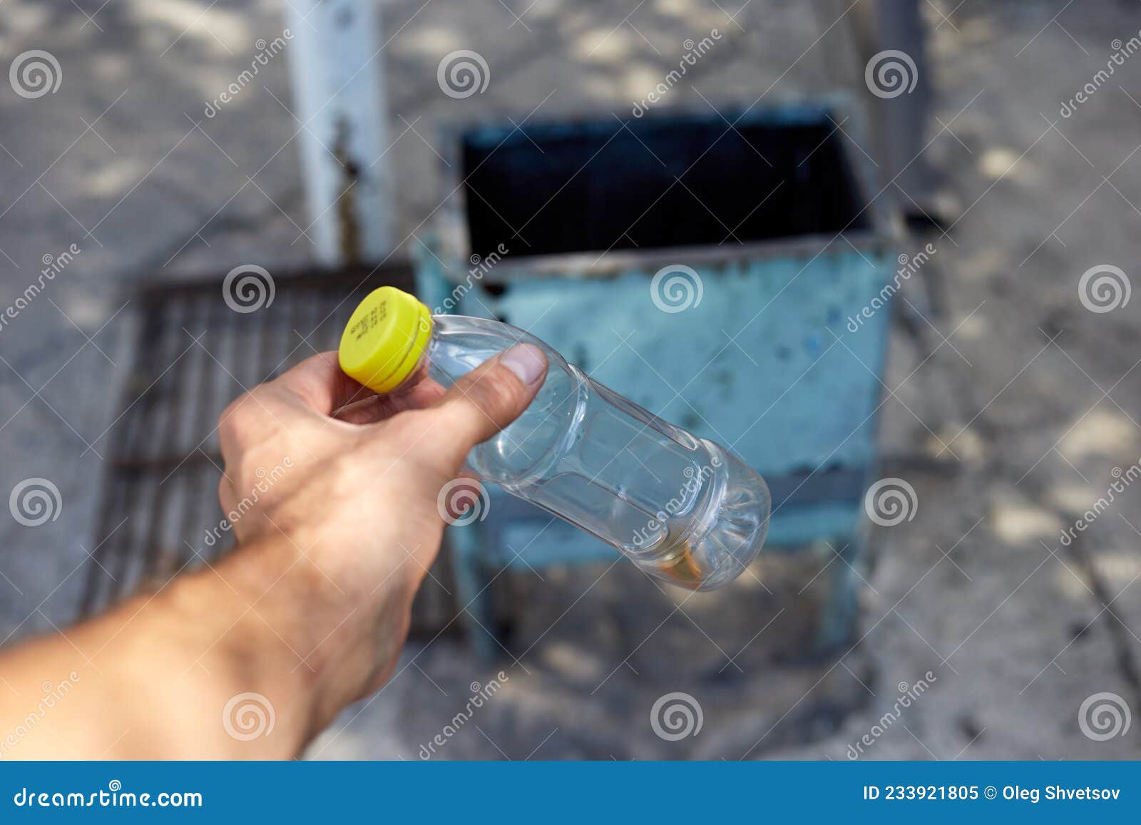 A Man Throws a Plastic Bottle into a Trash Can Stock Image - Image of ...