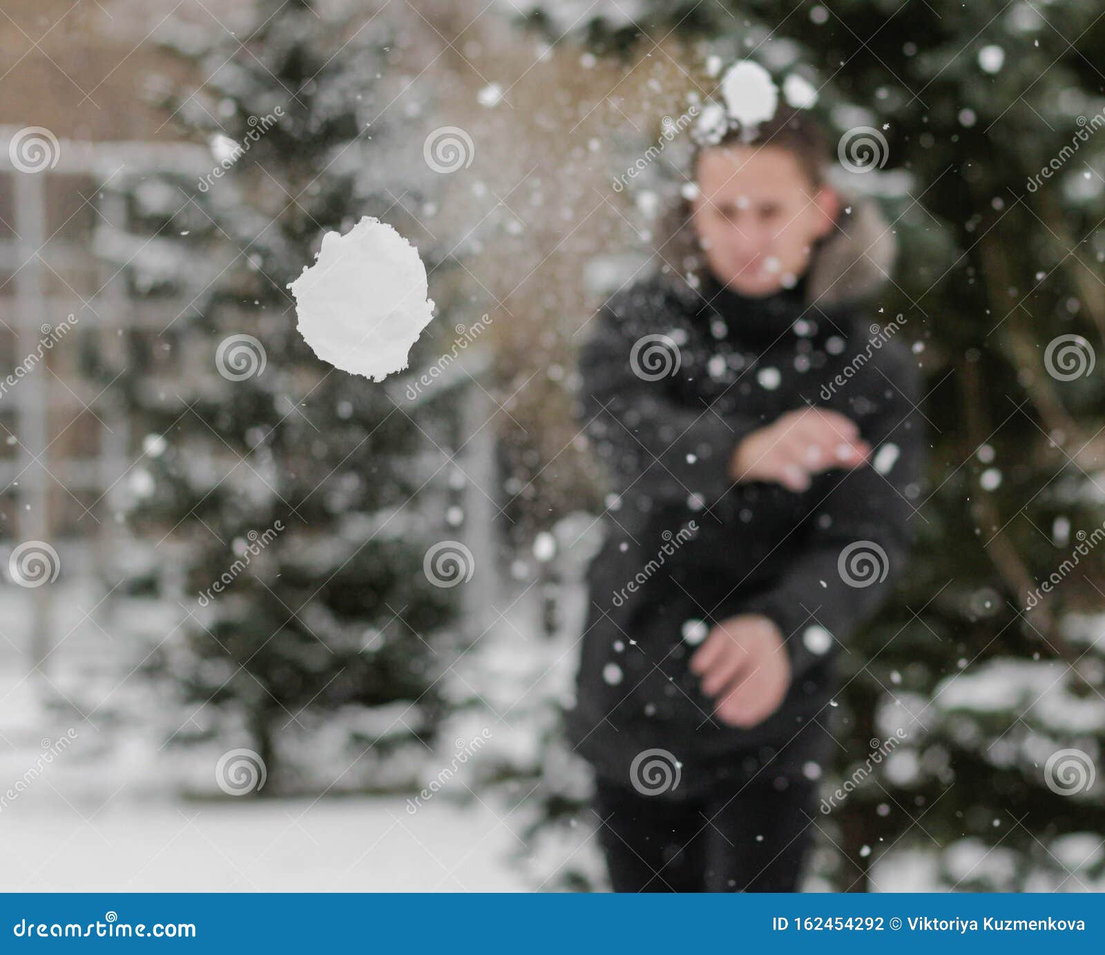 A Man Throws a Snowball at the Camera. the Snowball Shatters into ...
