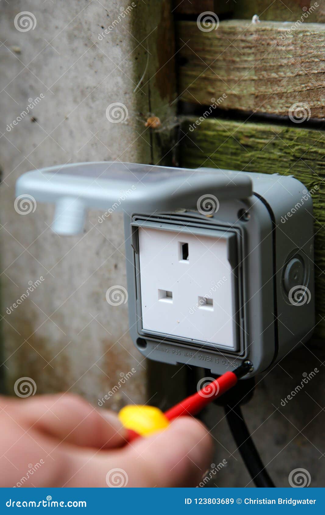 Man Tightening External Socket Box with an Electrical Screwdriver Stock ...