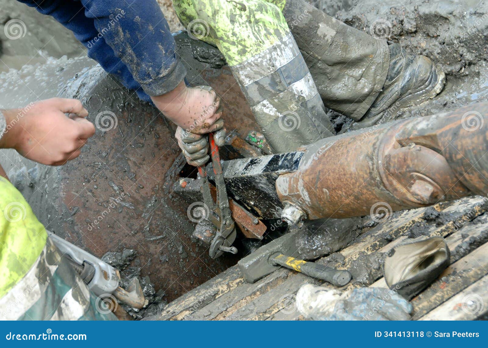 Man Tightens a Machine in the Mud Stock Photo - Image of mudhand ...