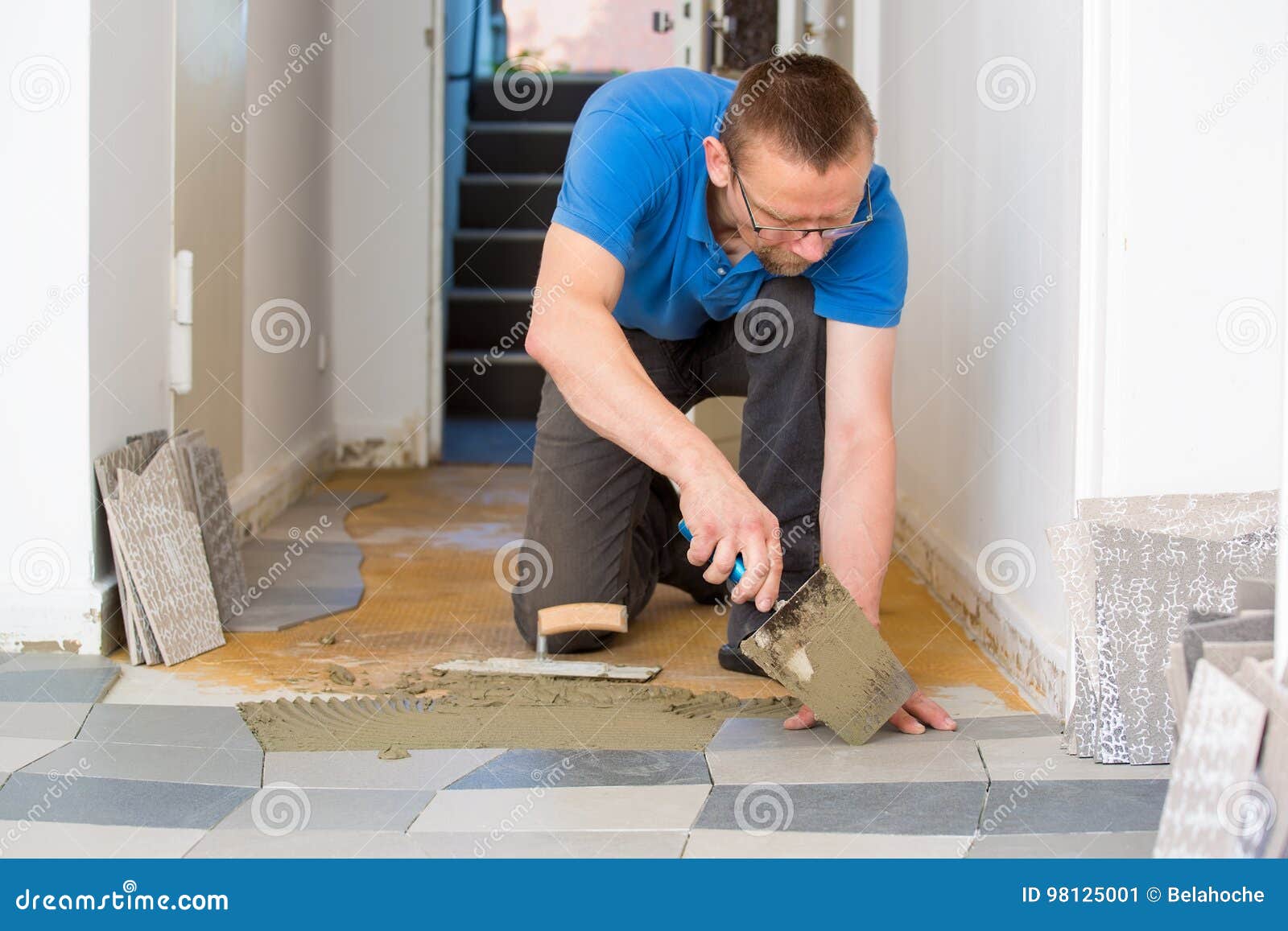 Man Tiling Floor Using Trowel Stock Image - Image of cement, trowel ...