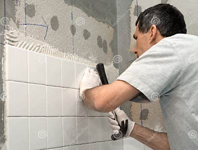 Man Tiling a Wall stock image. Image of sheet, mortar - 11572791