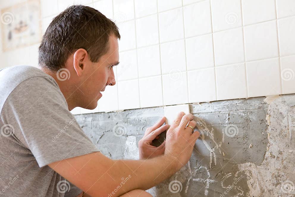 Man Tiling a Wall stock photo. Image of removal, caucasian - 5746870