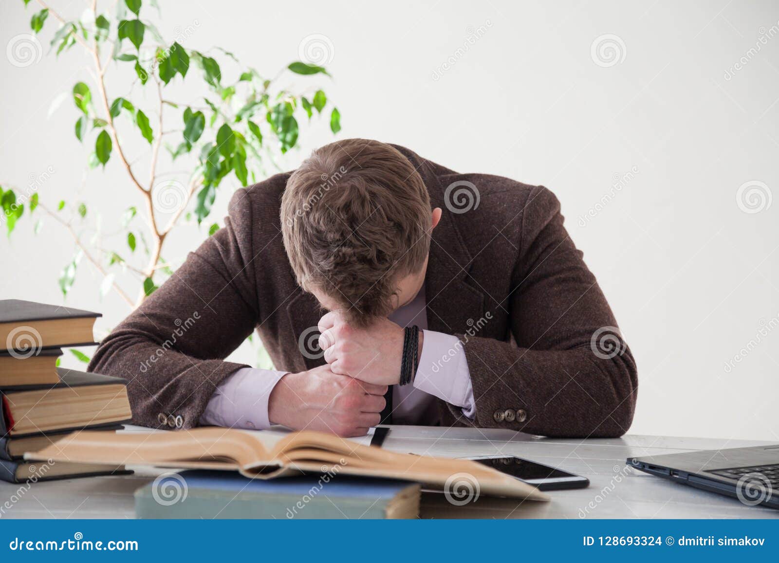 The Man is Tired and Asleep at a Table in a Business Office Stock Photo ...