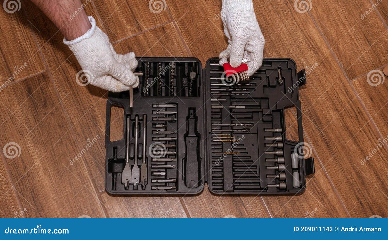 A Man with Tools in His Hands a Man Repairs a Toolbox Hexagons Drills ...