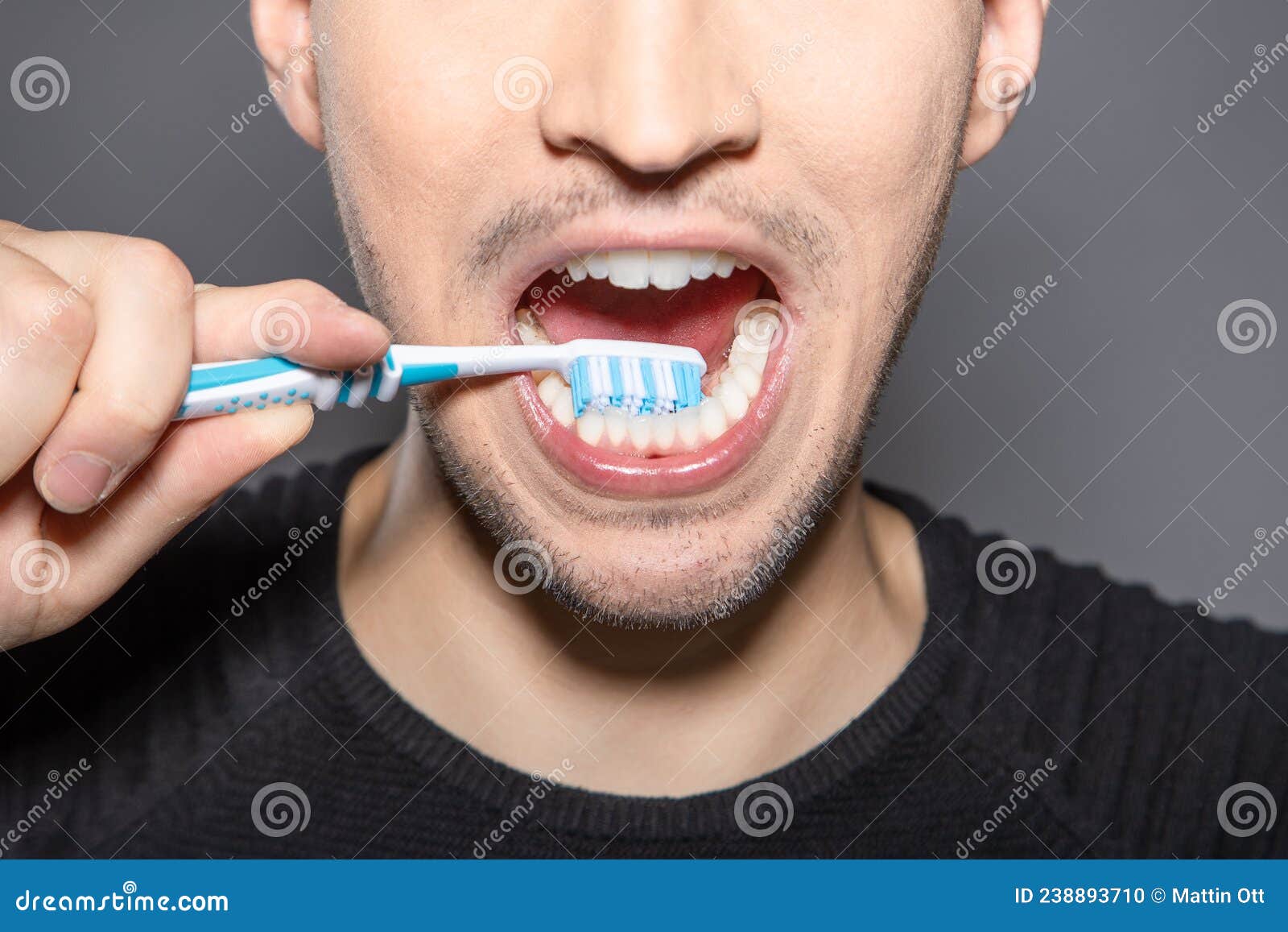 Man with Toothbrush on Back of His Bottom Teeth Brushes the Rear ...
