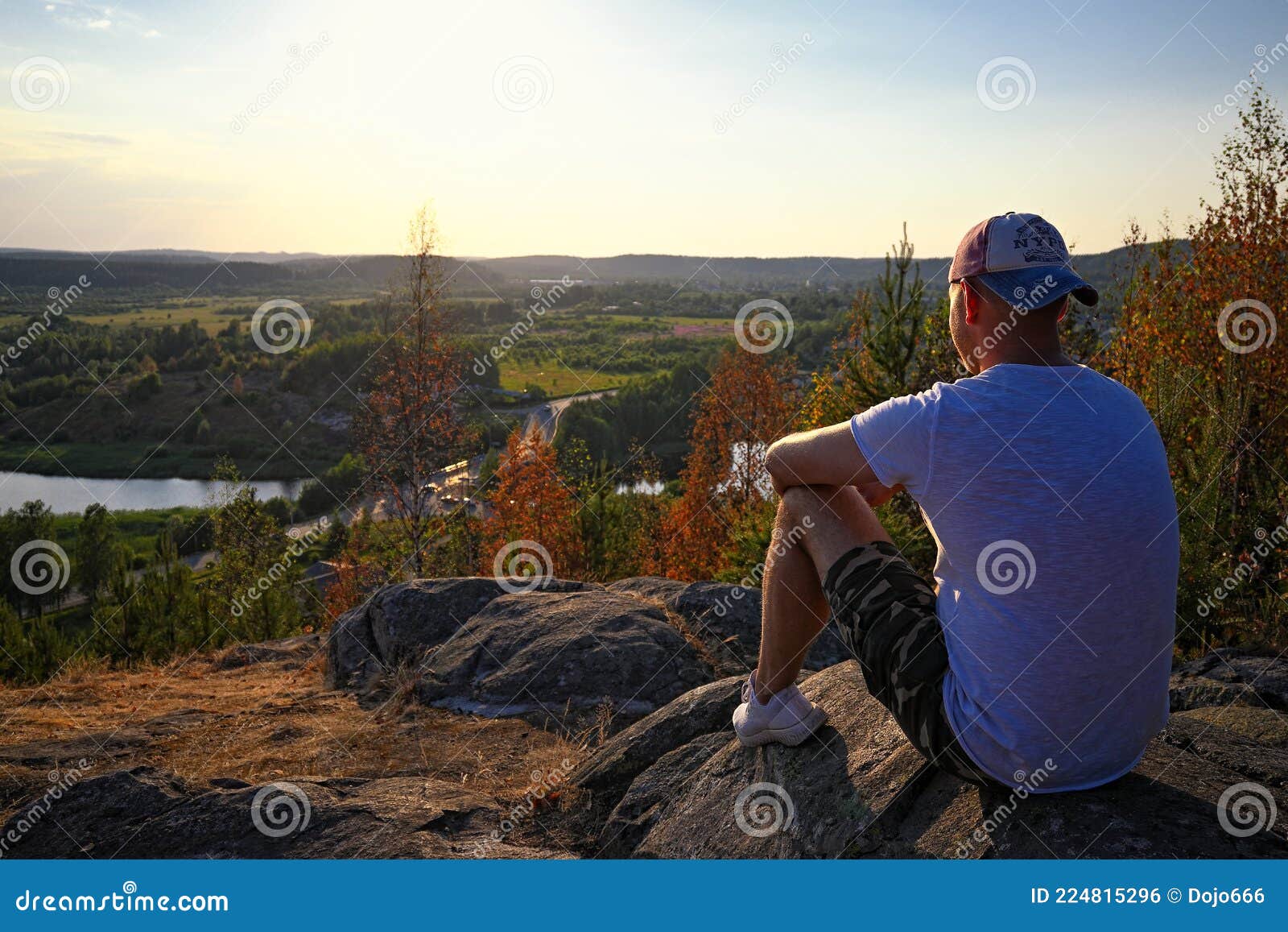 Man on Top Mountain Sitting on Rock and Look on Sunset Stock Photo ...