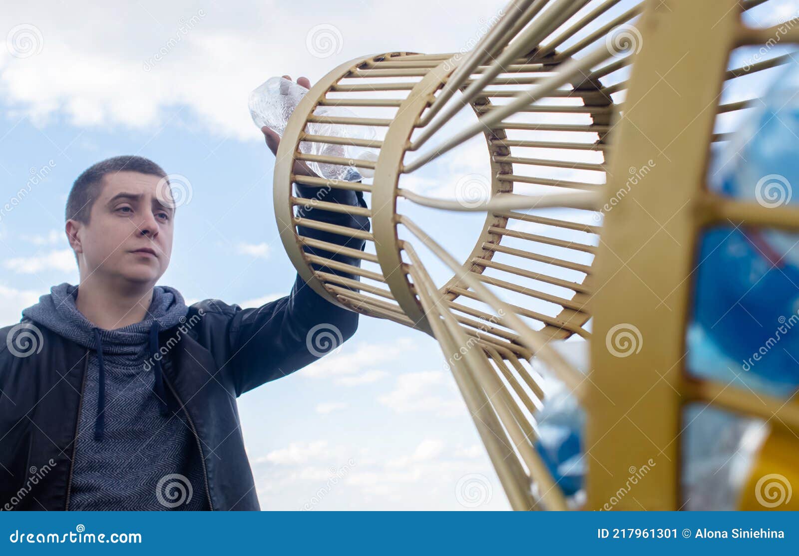 A Man Tosses a Plastic Bottle into a Plastic Container for Collection ...