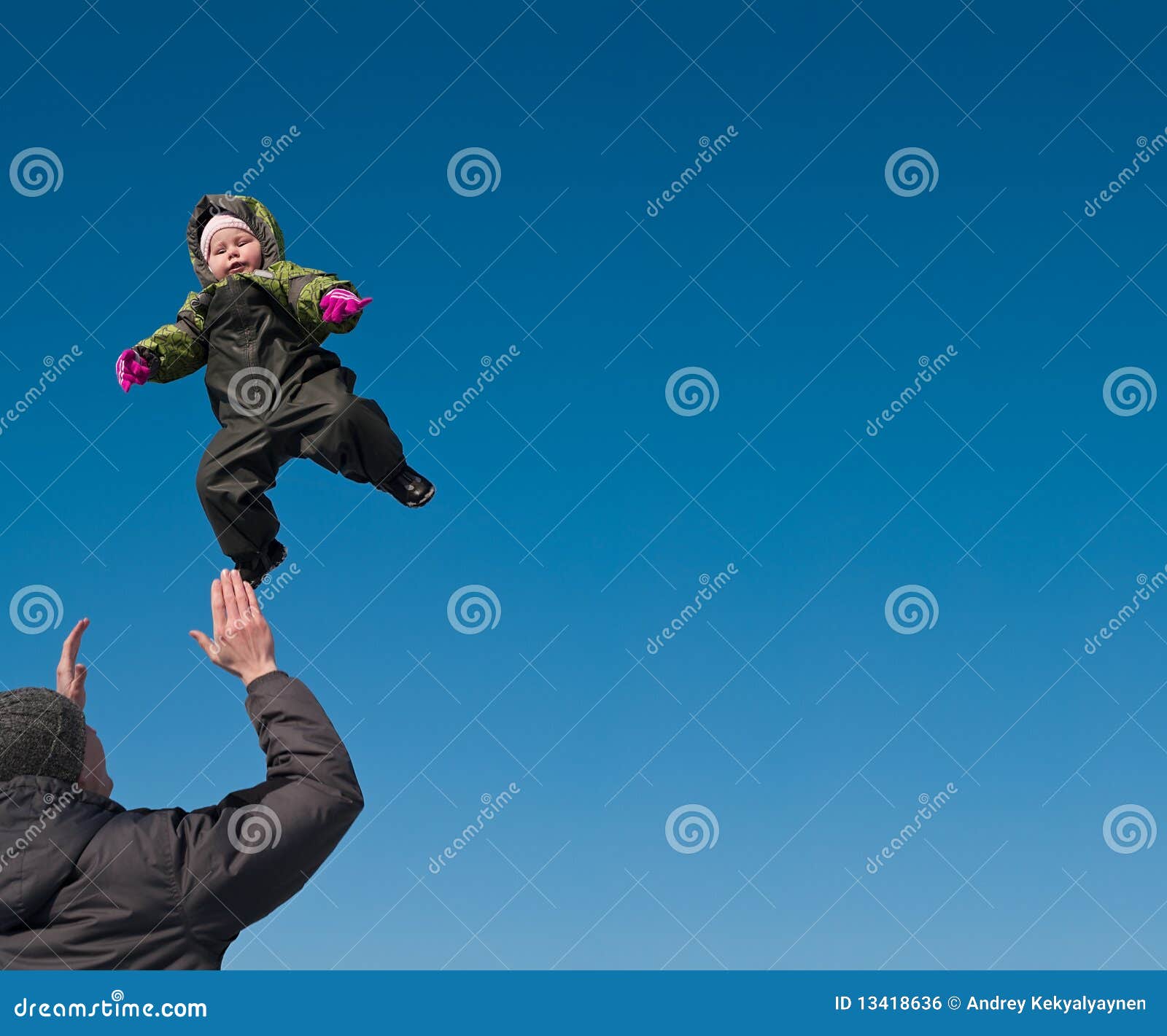Man tossing up a child stock photo. Image of blue, family - 13418636