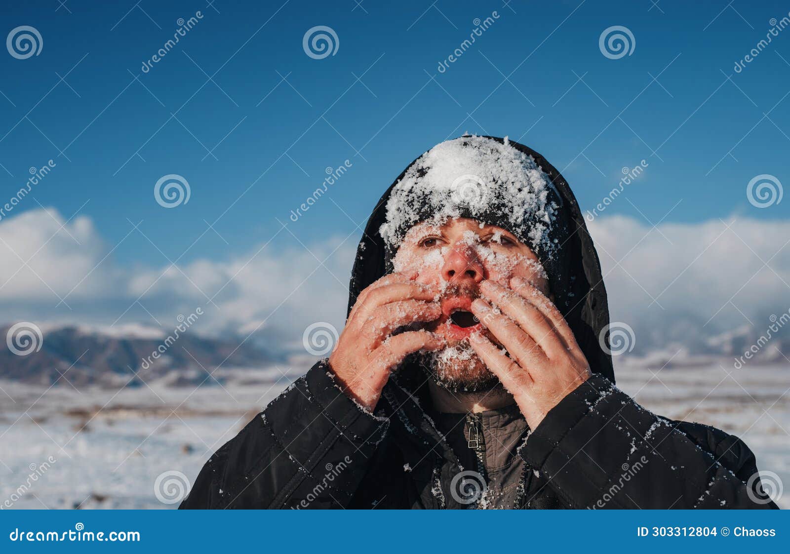Man Touching His Face with Snow on Mountains Background in Winter Stock ...