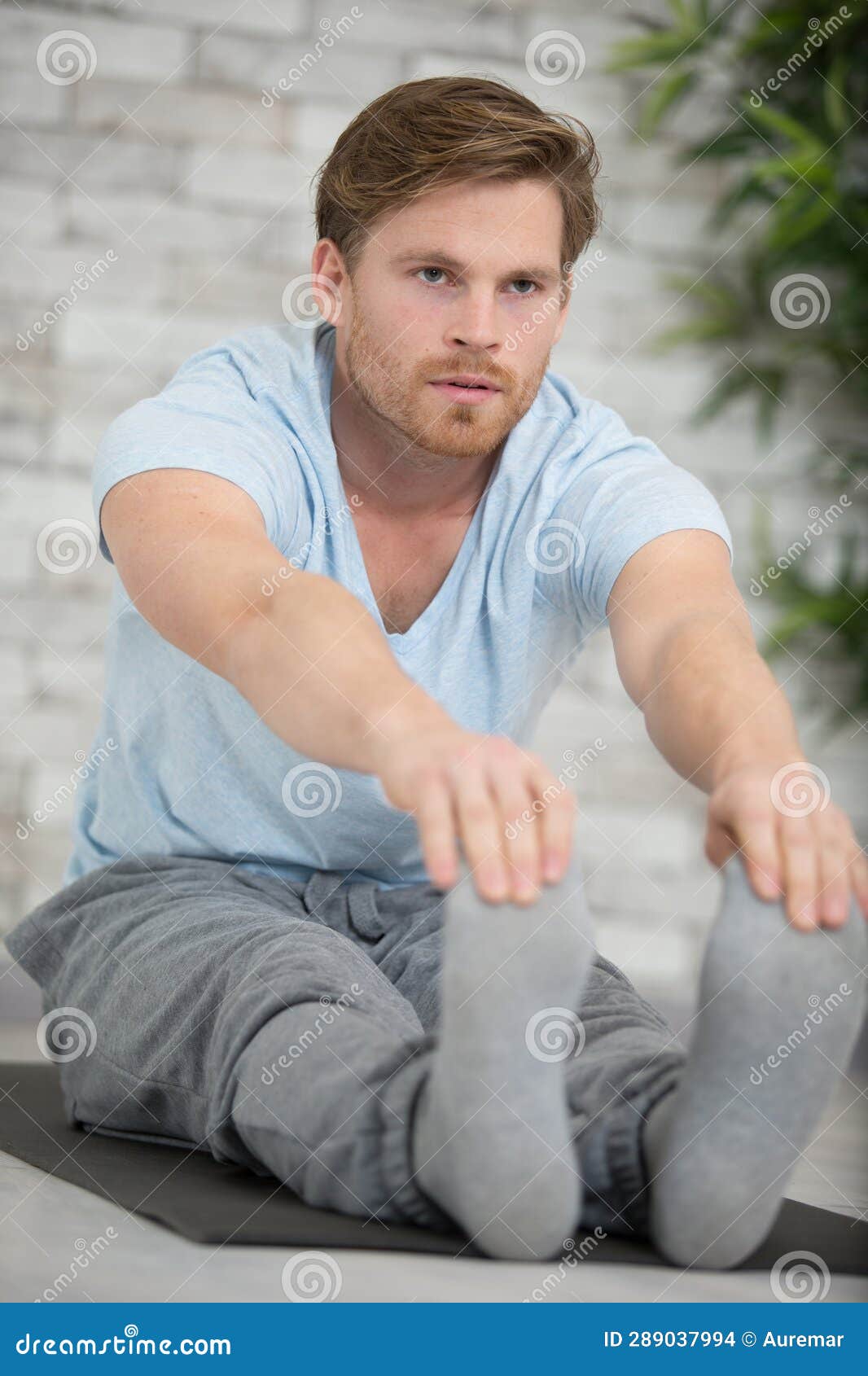 Man Touching Toes from Sitting Position Stretching Stock Photo - Image ...