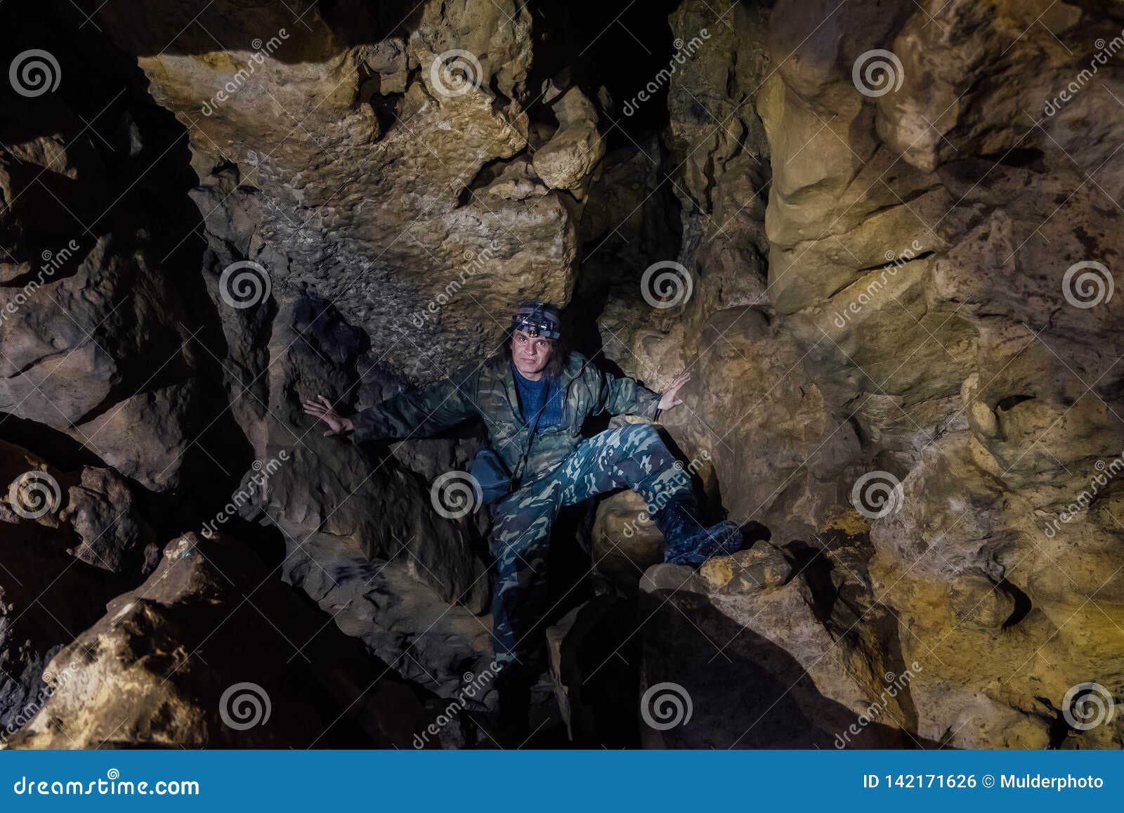 Man Tourist in Camouflage Suit Explores Cave Stock Photo - Image of ...