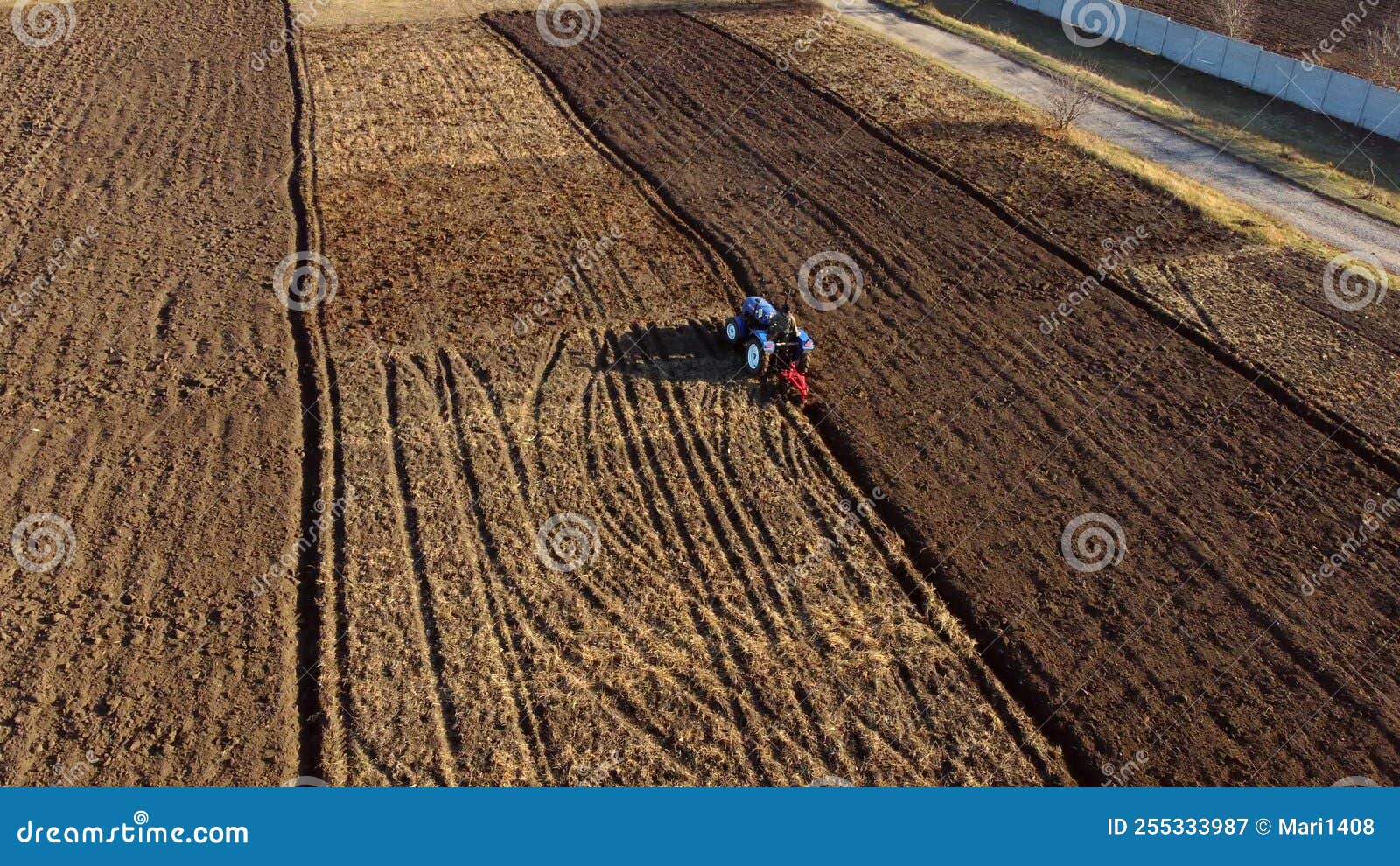 A Man on a Tractor Digging the Ground. Tractor Driver Plowing the Field ...