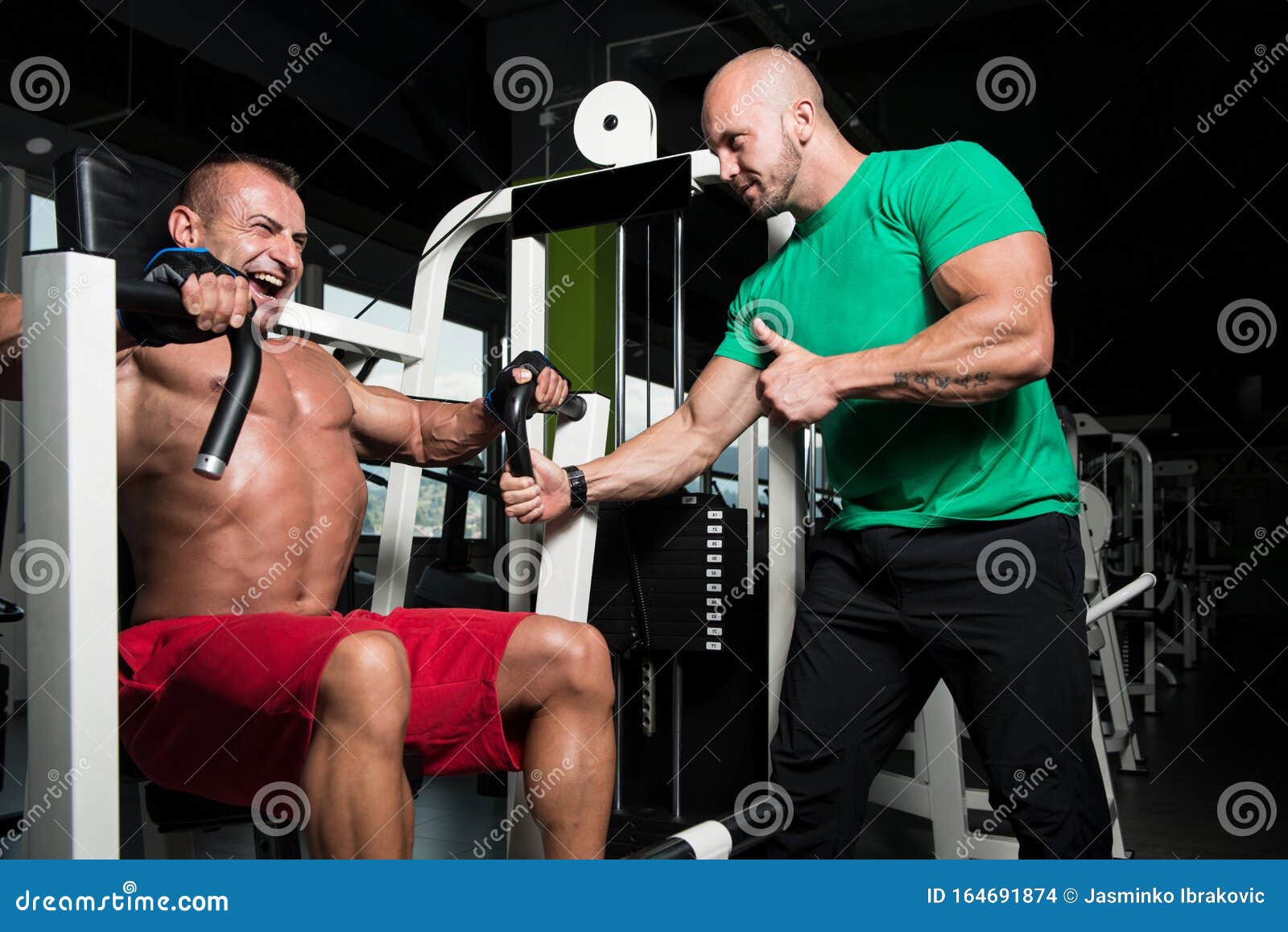 Man Train Chest on Machine with Personal Trainer Stock Photo - Image of ...