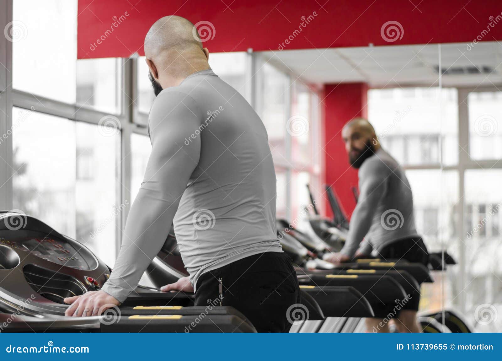 Man Training on Treadmill, Looking at His Reflection in Mirror after ...