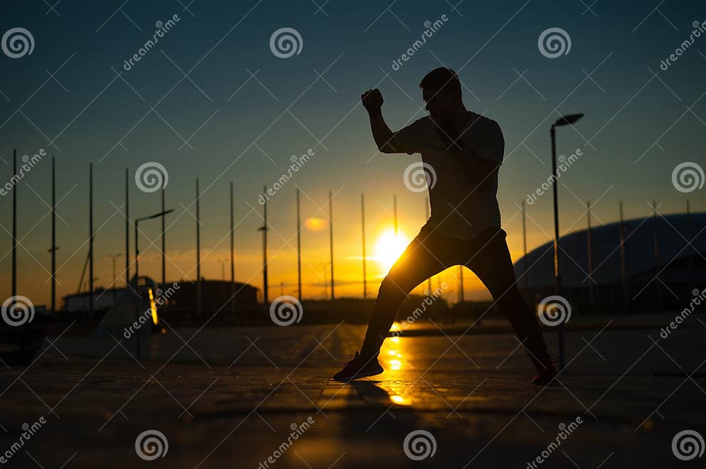 A Man Trains Boxing at Sunset Outdoors. Stock Photo - Image of bandage ...