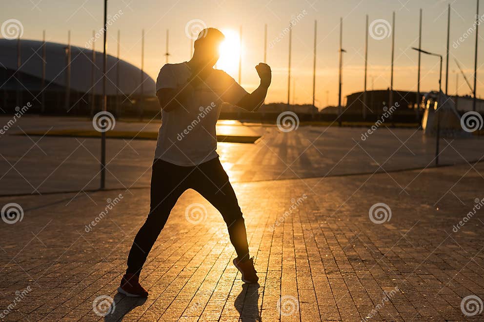 A Man Trains Boxing at Sunset Outdoors. Stock Image - Image of fist ...