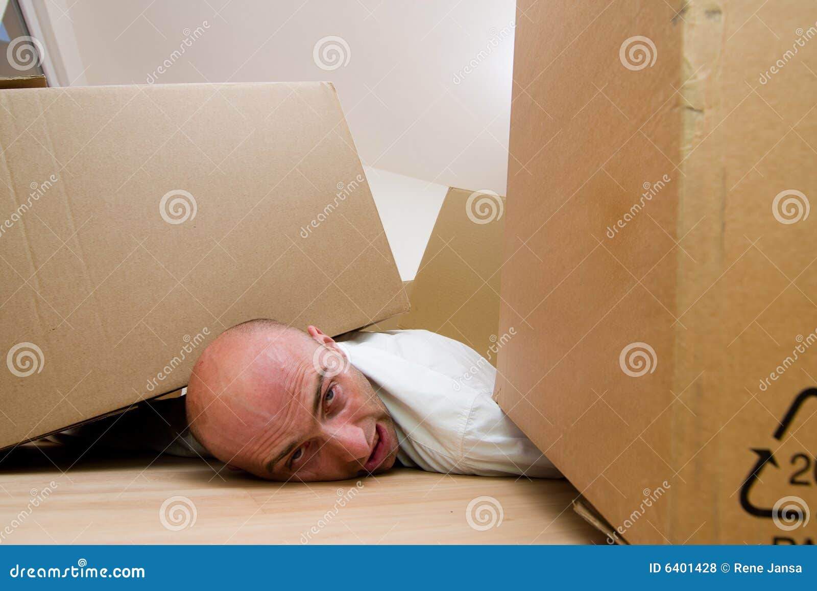 Man trapped under boxes stock photo. Image of floor, room - 6401428