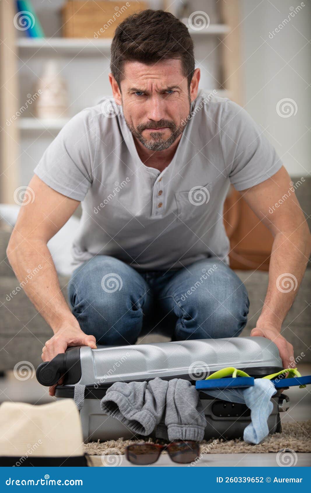 Man Tries To Close Full Suitcase Stock Photo - Image of casual, journey ...
