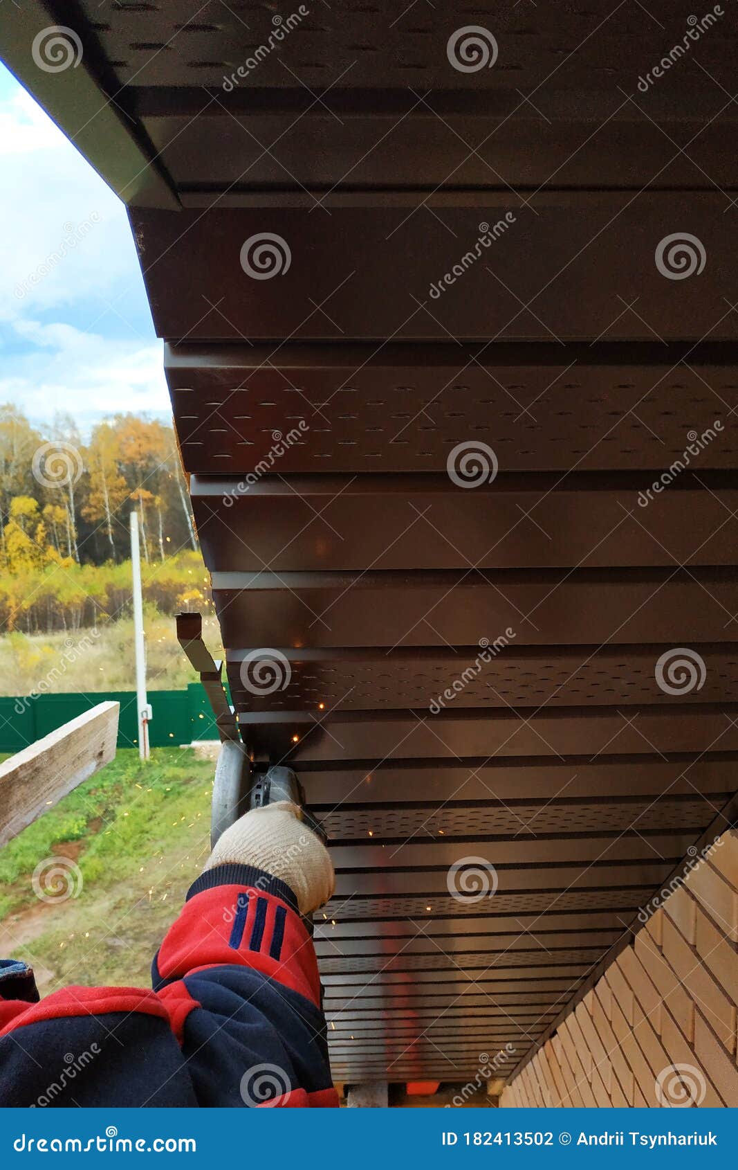 A Man Trims a Curtain Rod with an Angle Grinder Stock Photo - Image of ...