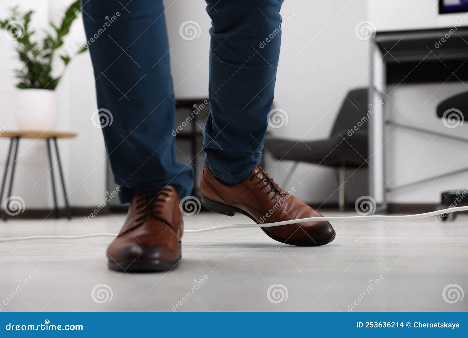 Man Tripping Over Cord in Office, Closeup Stock Photo - Image of home ...