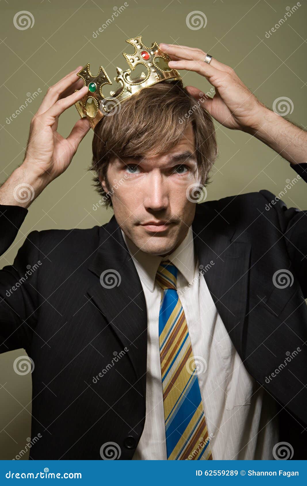 Man trying on crown stock image. Image of humor, male - 62559289